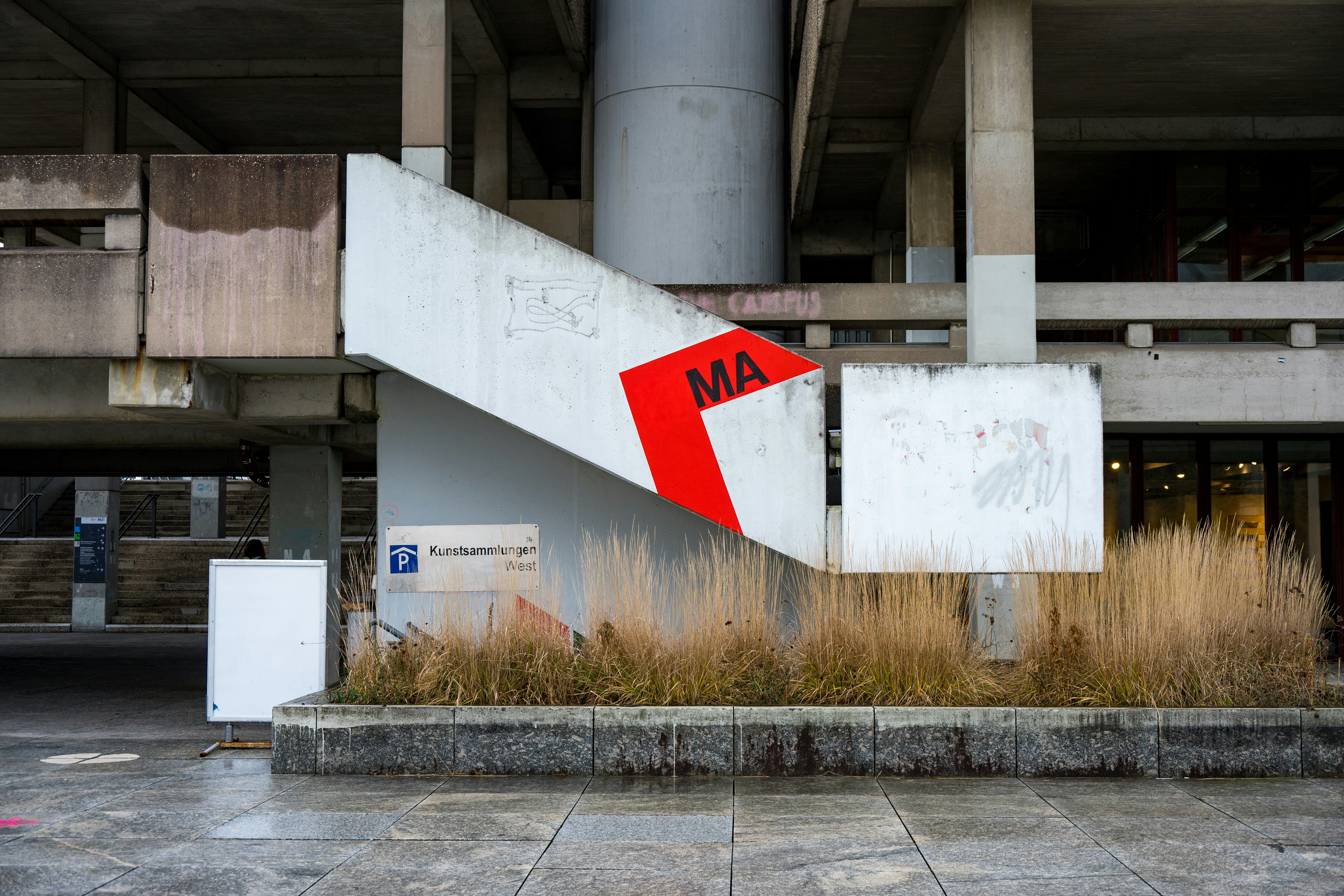 Concrete Geometry and Red Sign: A Quiet City Entrance