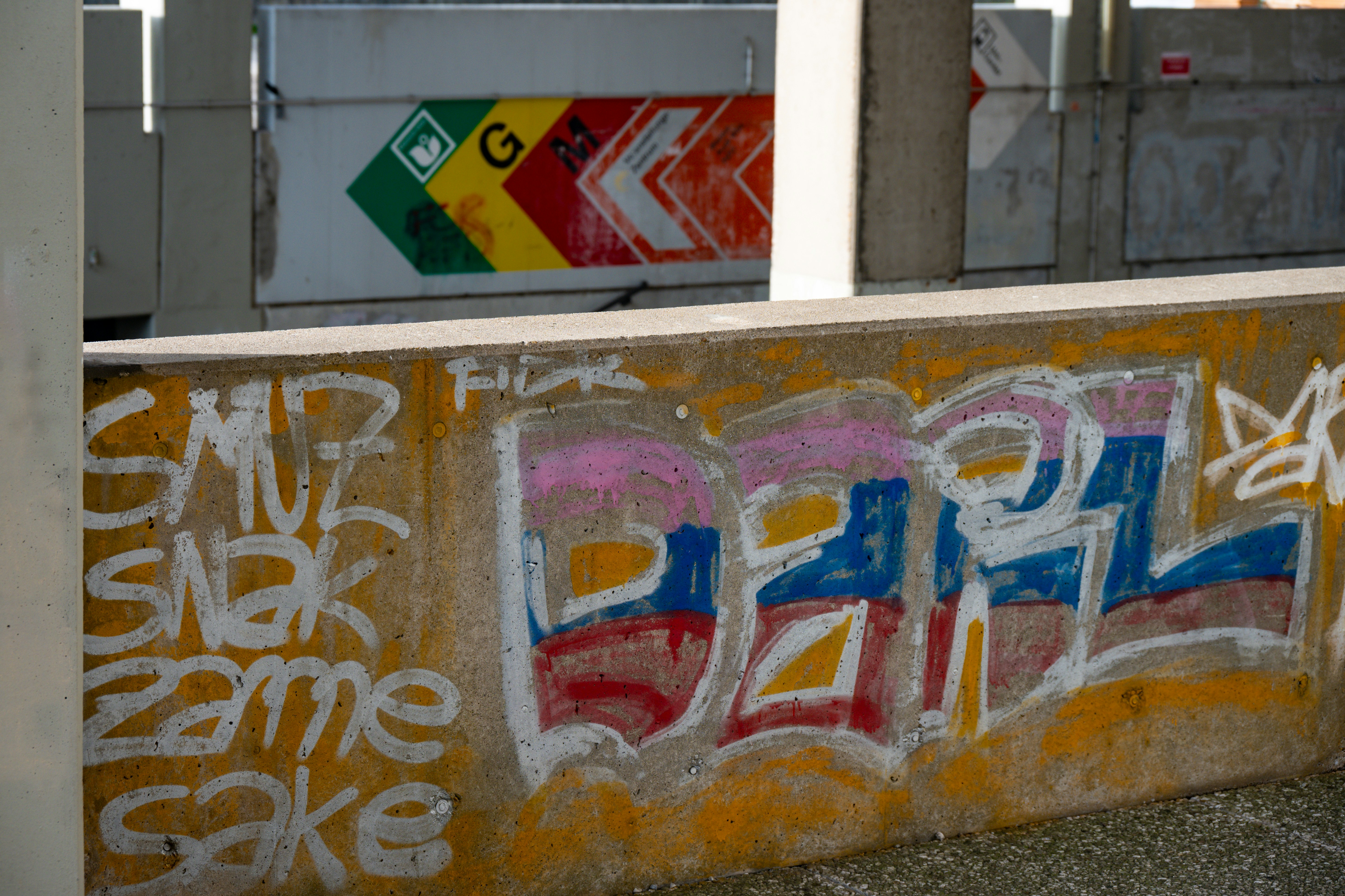 Graffiti Wall with Colorful Block Letters Framed by Concrete Barriers