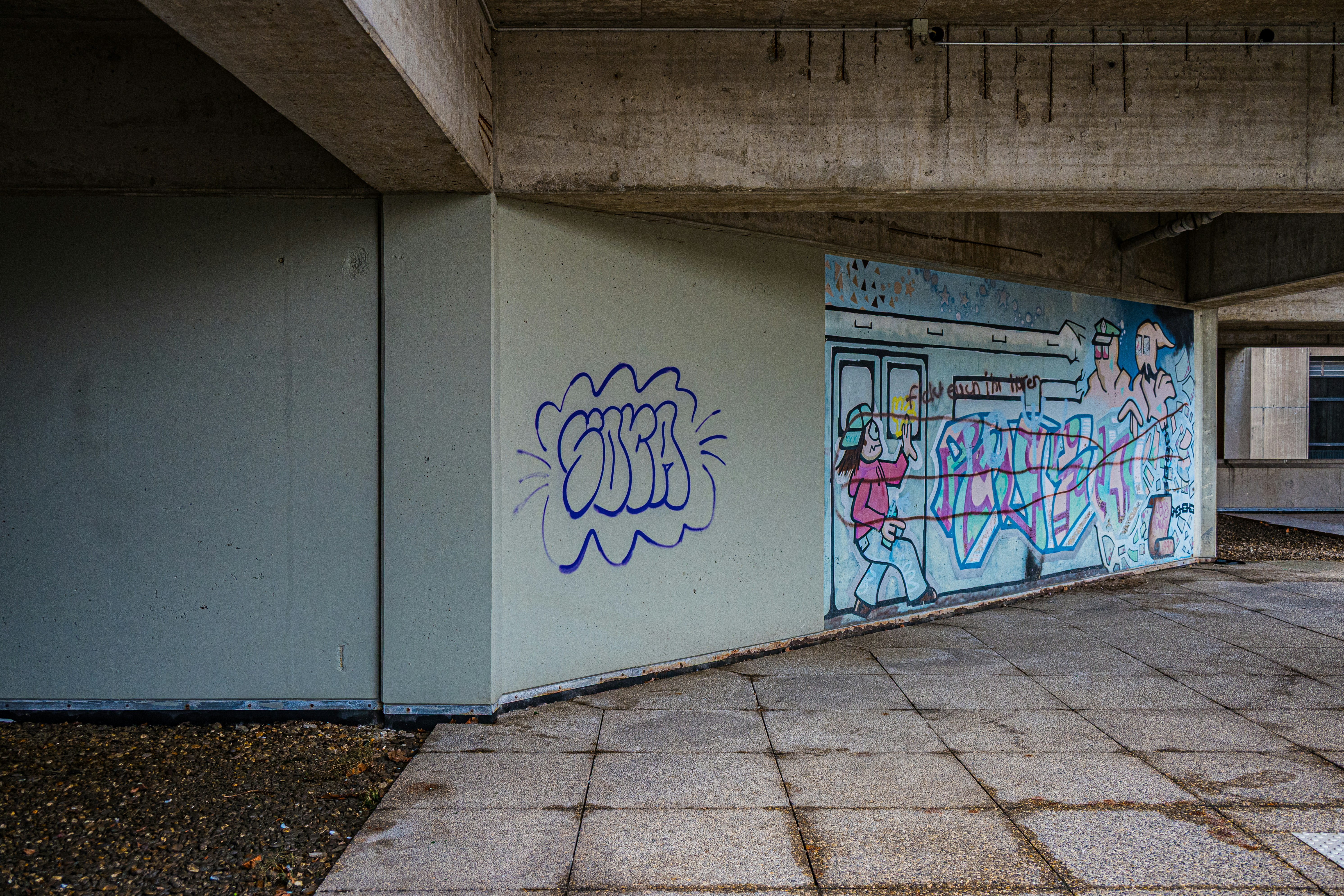 Underpass murals: a quiet street-level story unfolds along the concrete wall