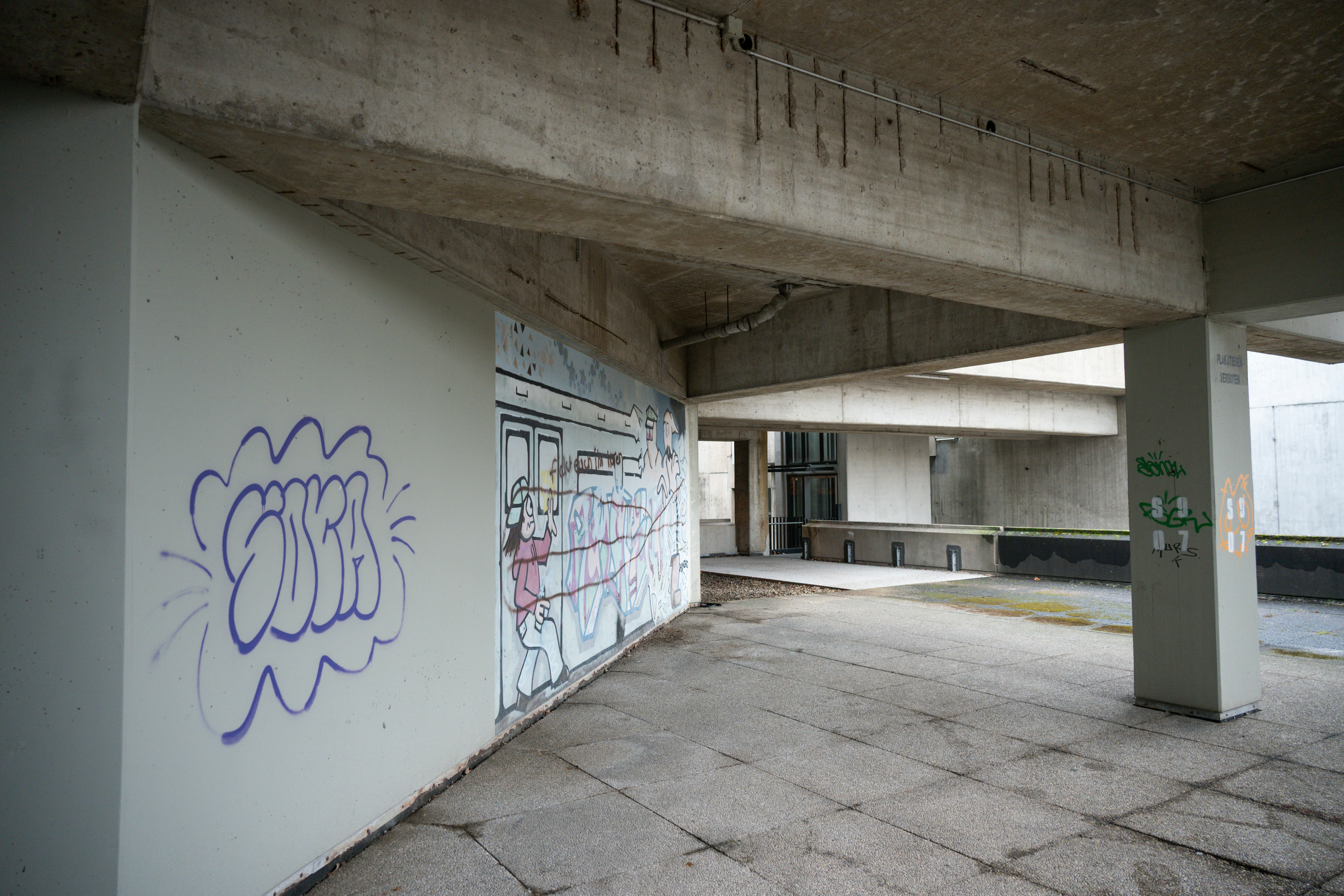 Concrete Corridor with Graffiti: An Urban Minimalist Scene