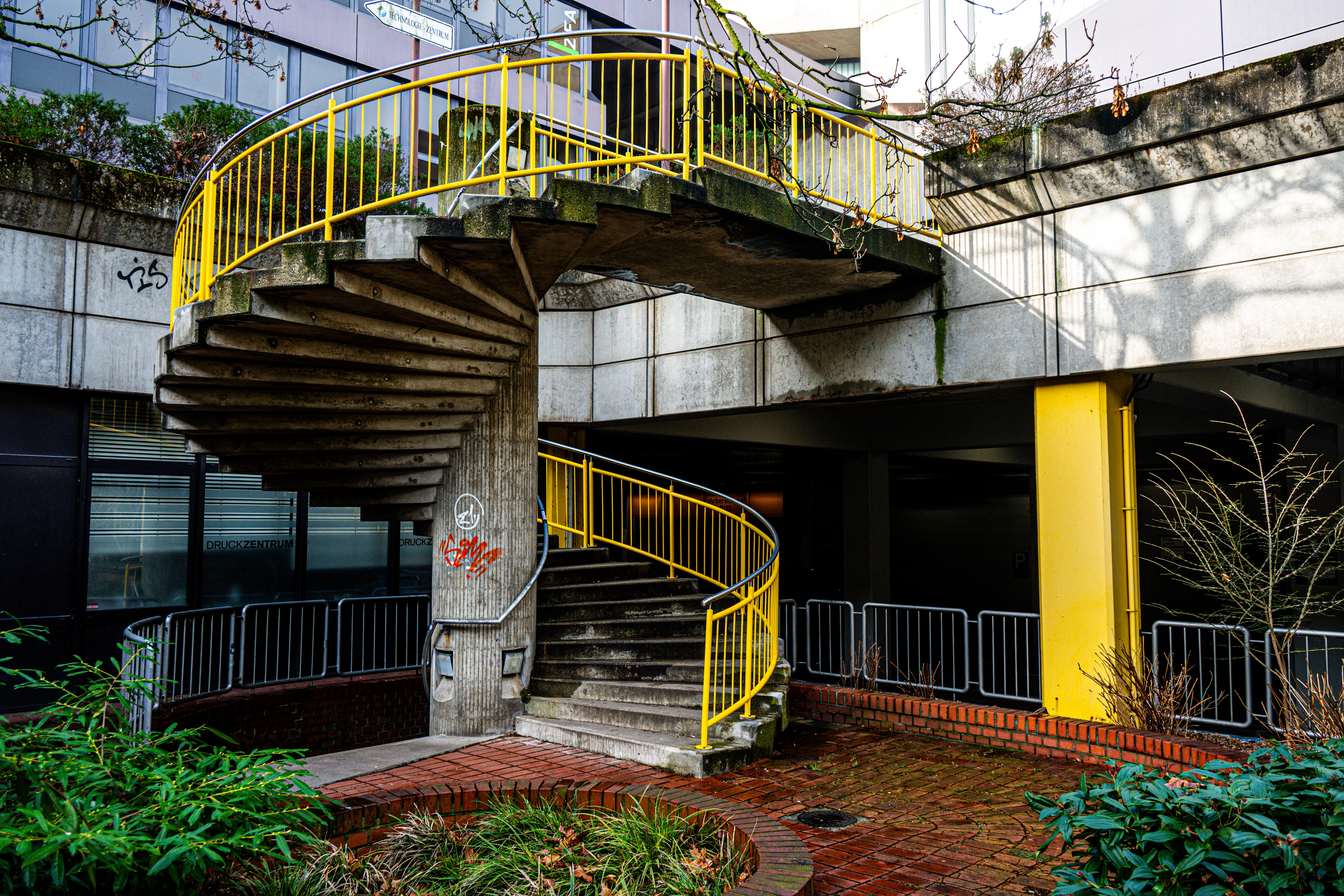 Spiral Descent: Urban Concrete and Yellow Railing
