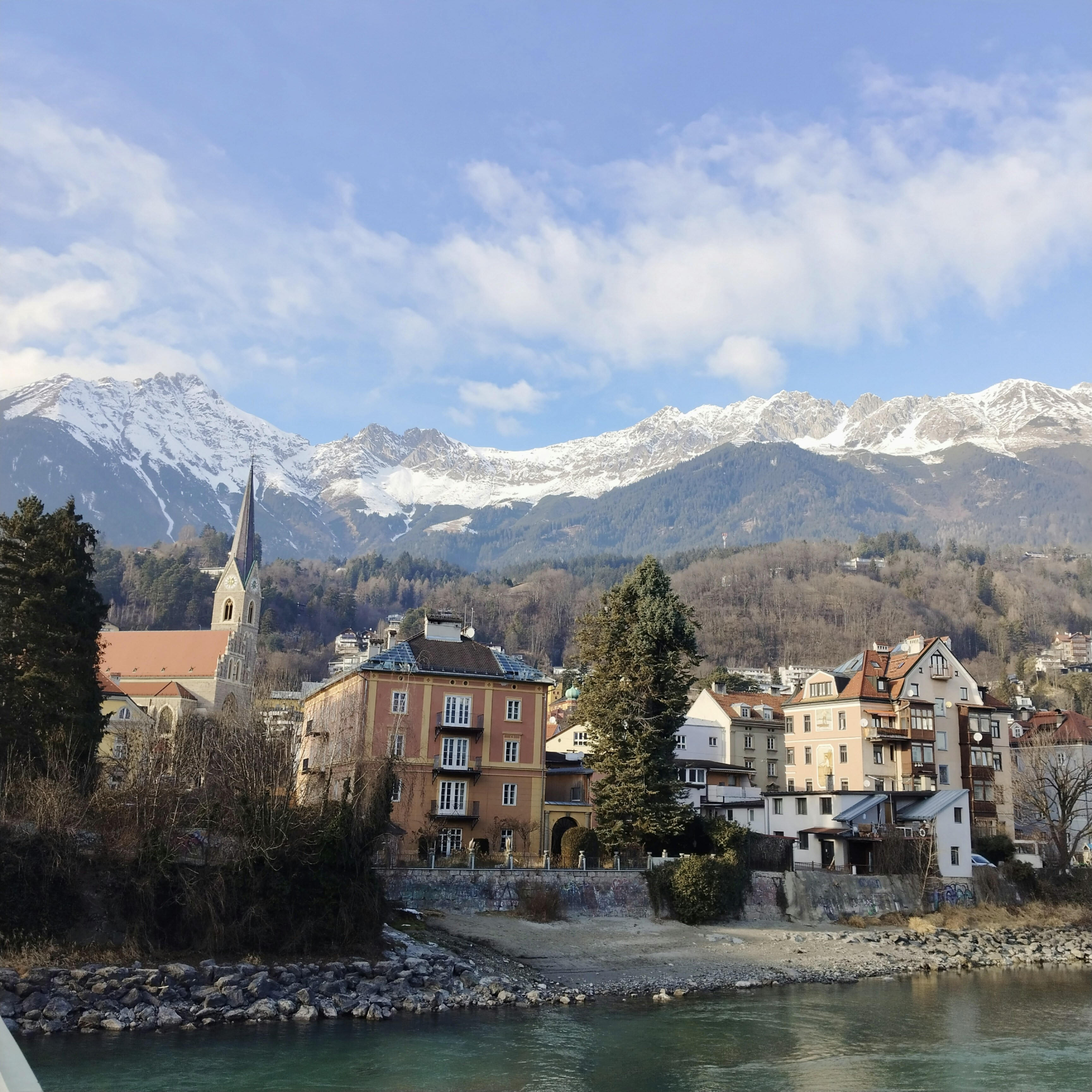 Town with snow-capped mountains in the background