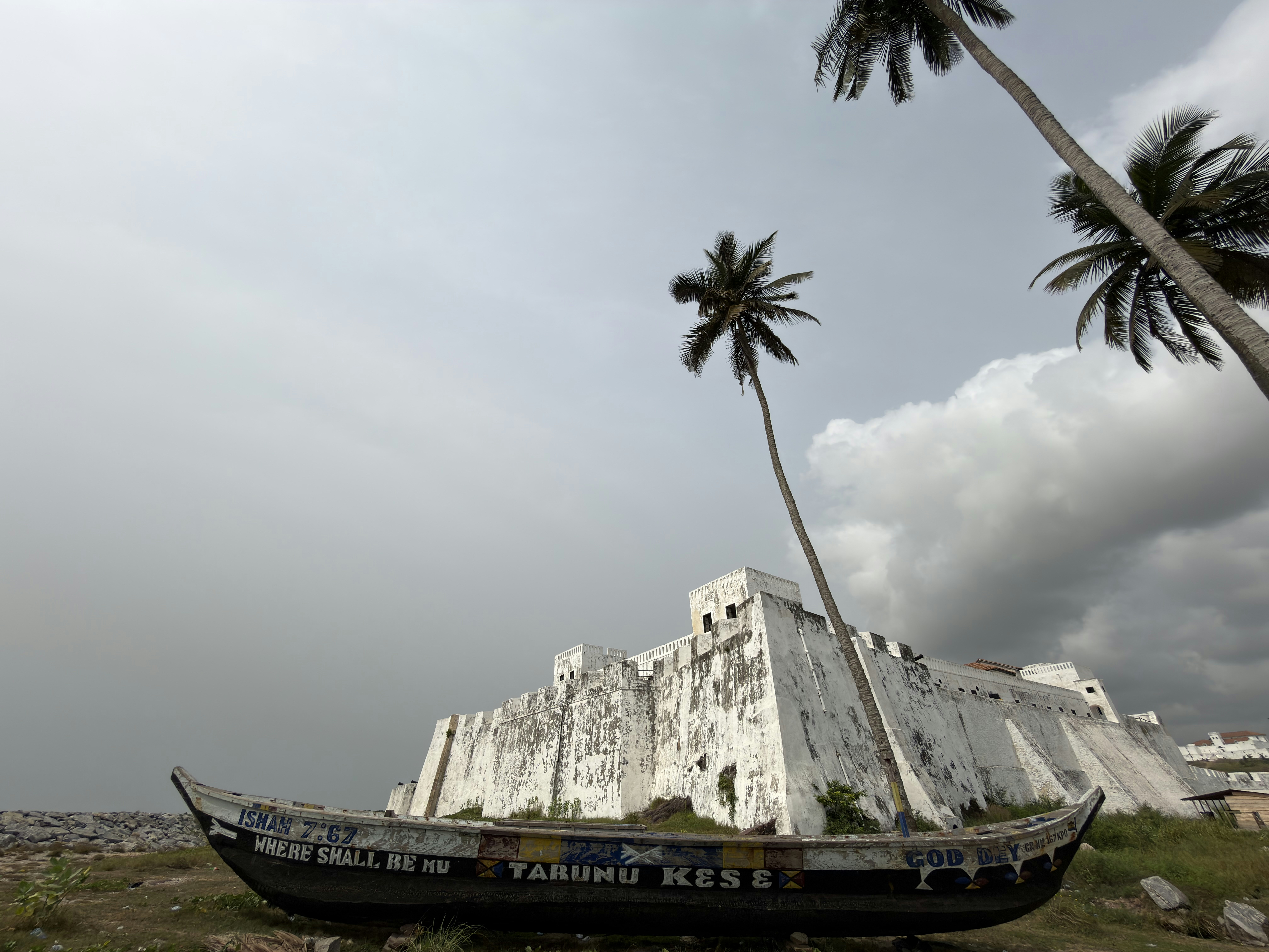 Old boat in front of a historic white building