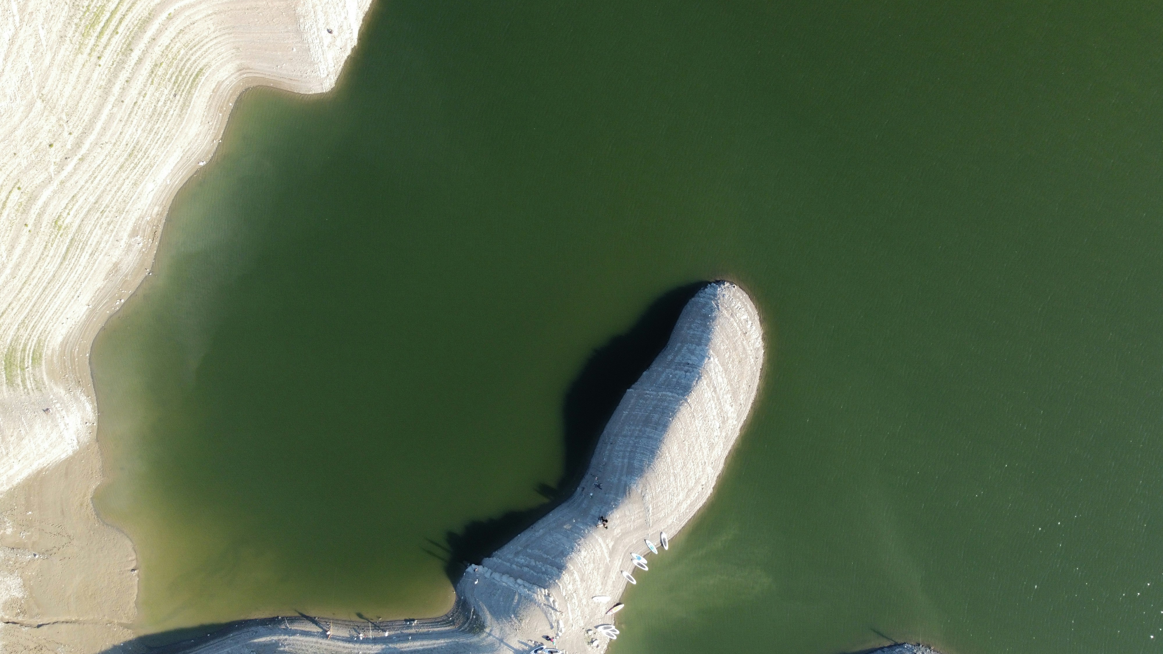 White sand bar pierces emerald inlet: a lone tail of land