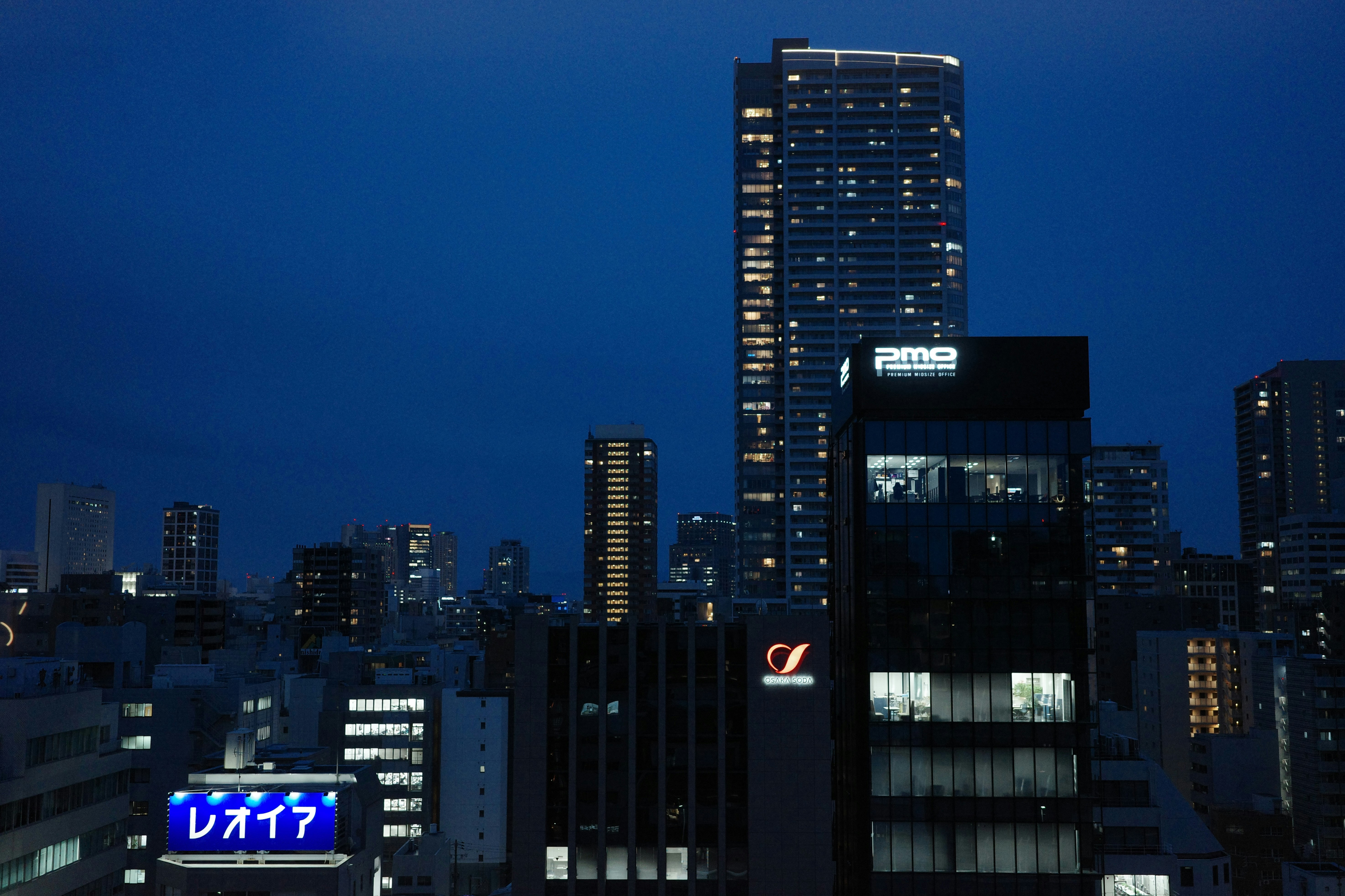 Nightfall in Neon: A Quiet Cityscape Under Blue Skies
