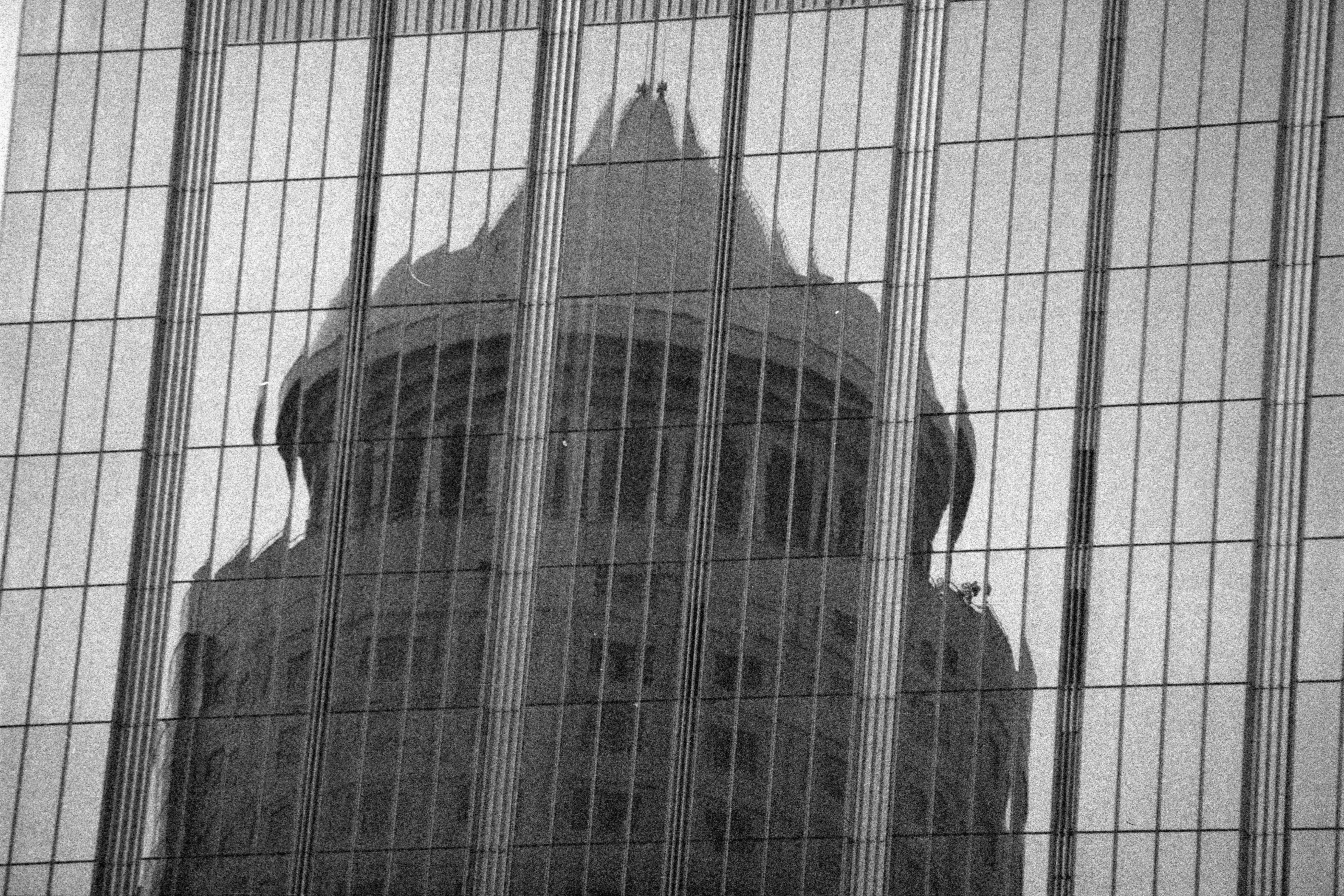 Through the Bars: A Monument Framed by Gridded Glass