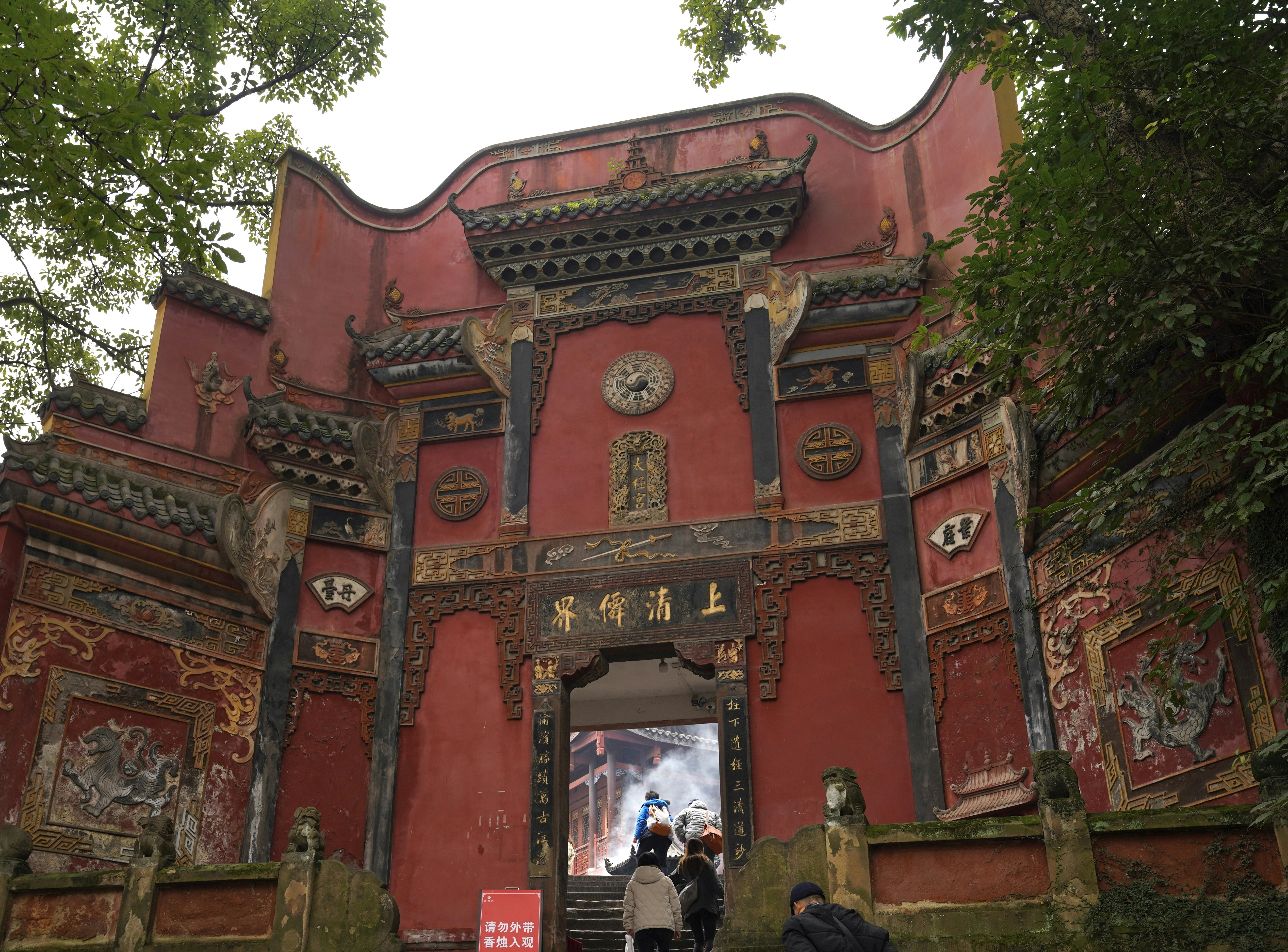 Gateway to the Red Courtyard: A Temple Entrance framed by weathered guardians