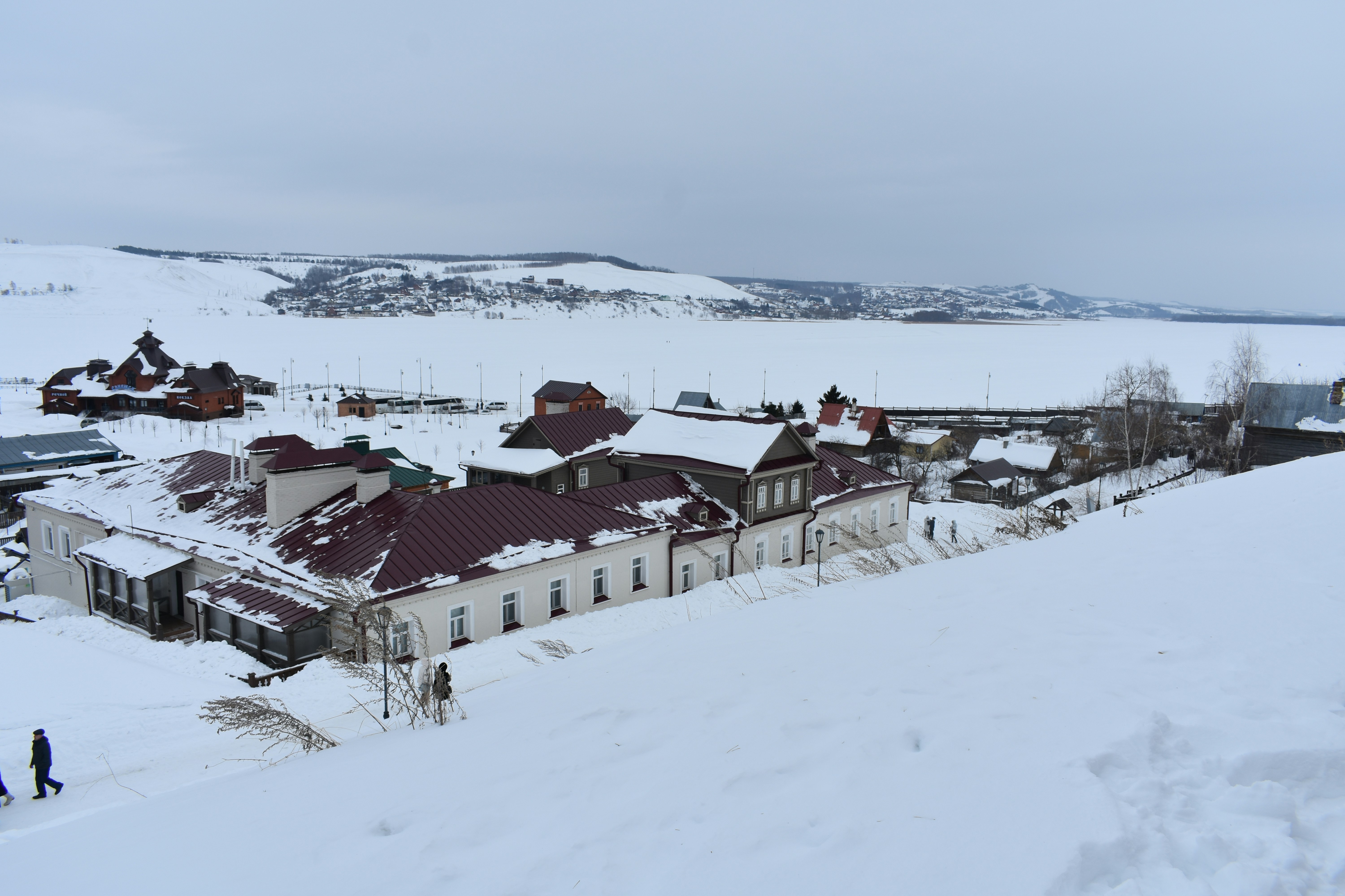 Snowbound Village: Rooftops and Tracks Under a Grey Sky