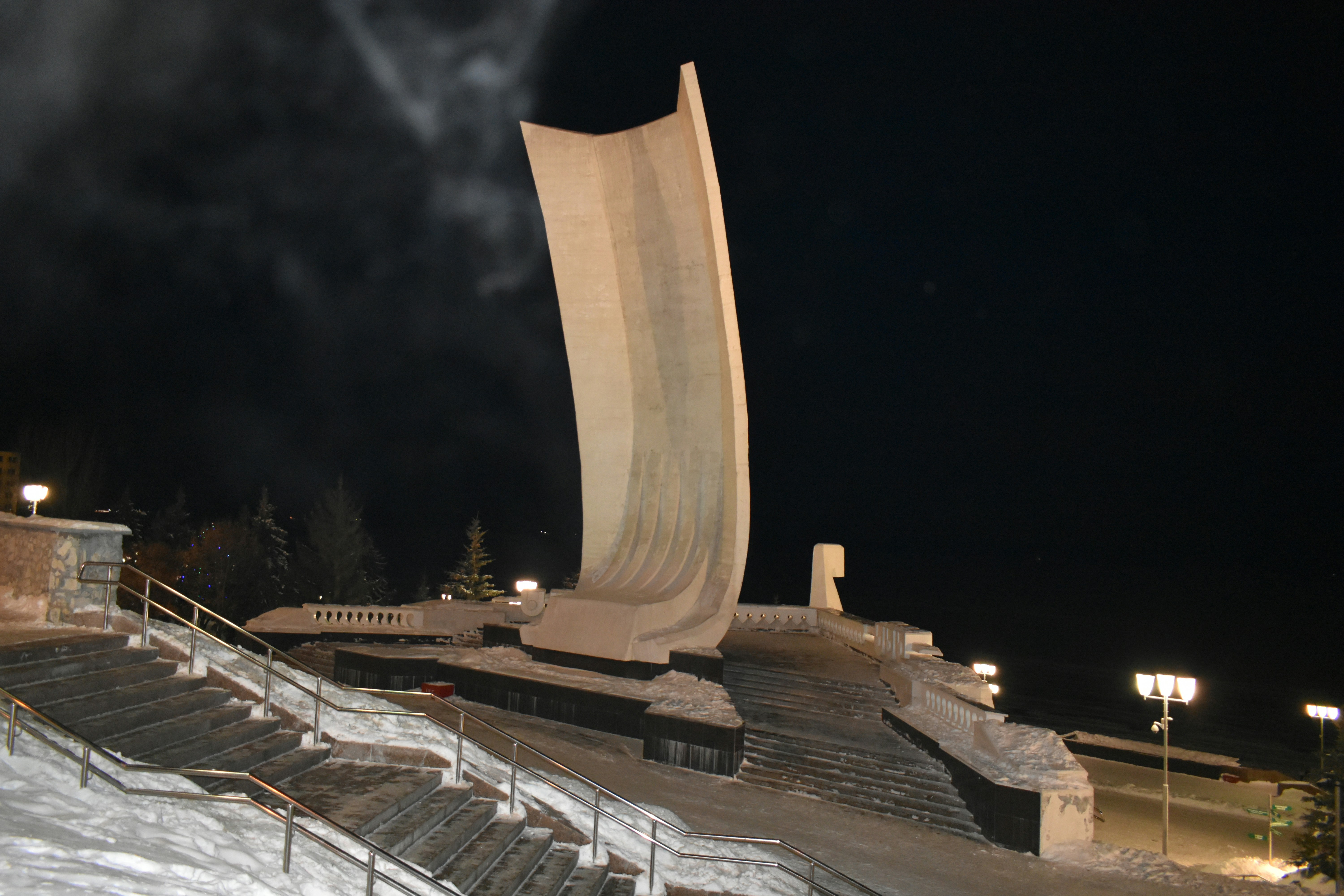Moonlit Monument: Snow-bound Steps toward a Sleek Arch
