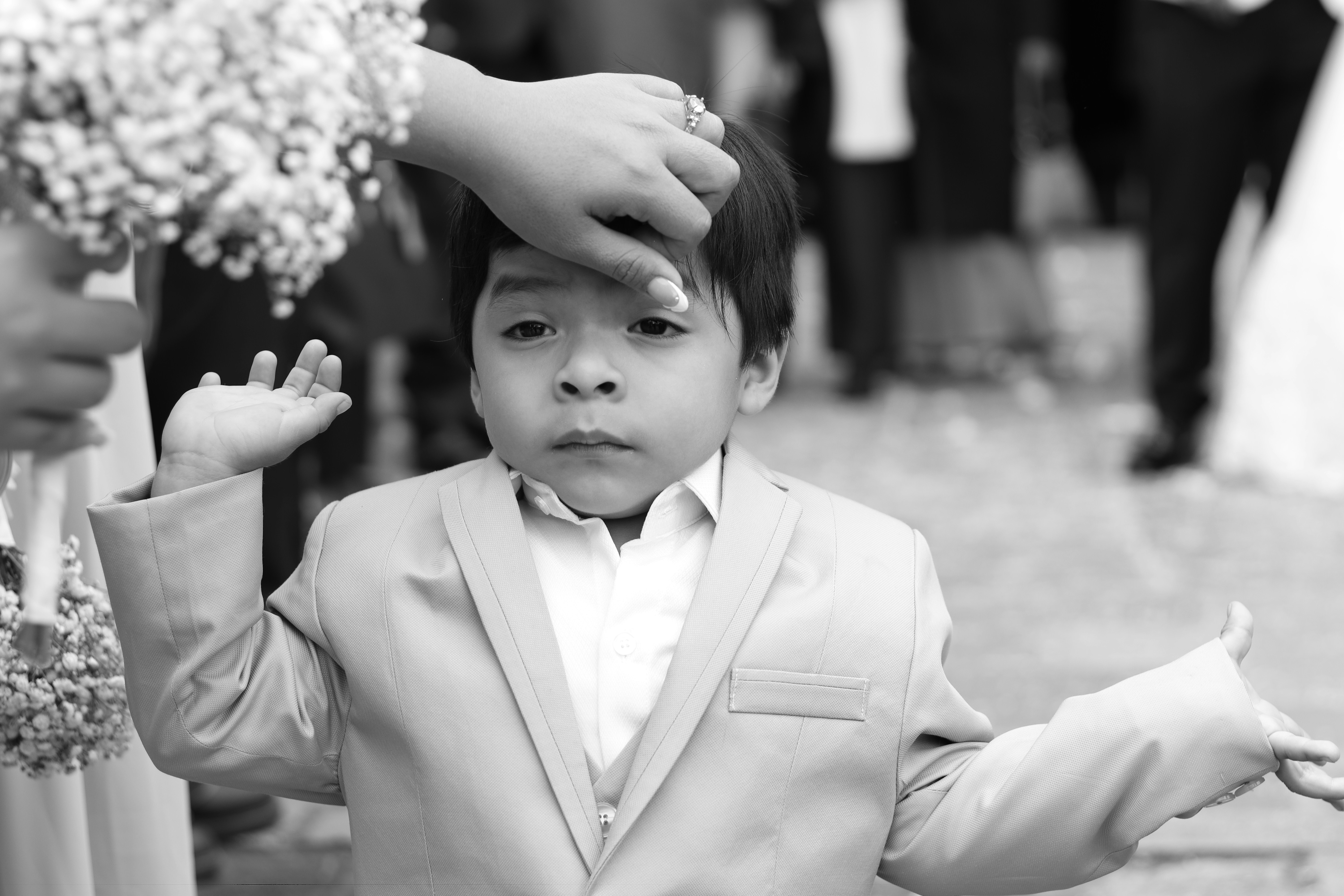 Tiny Ringbearer Stance: A Moment of Calm Amid Celebration