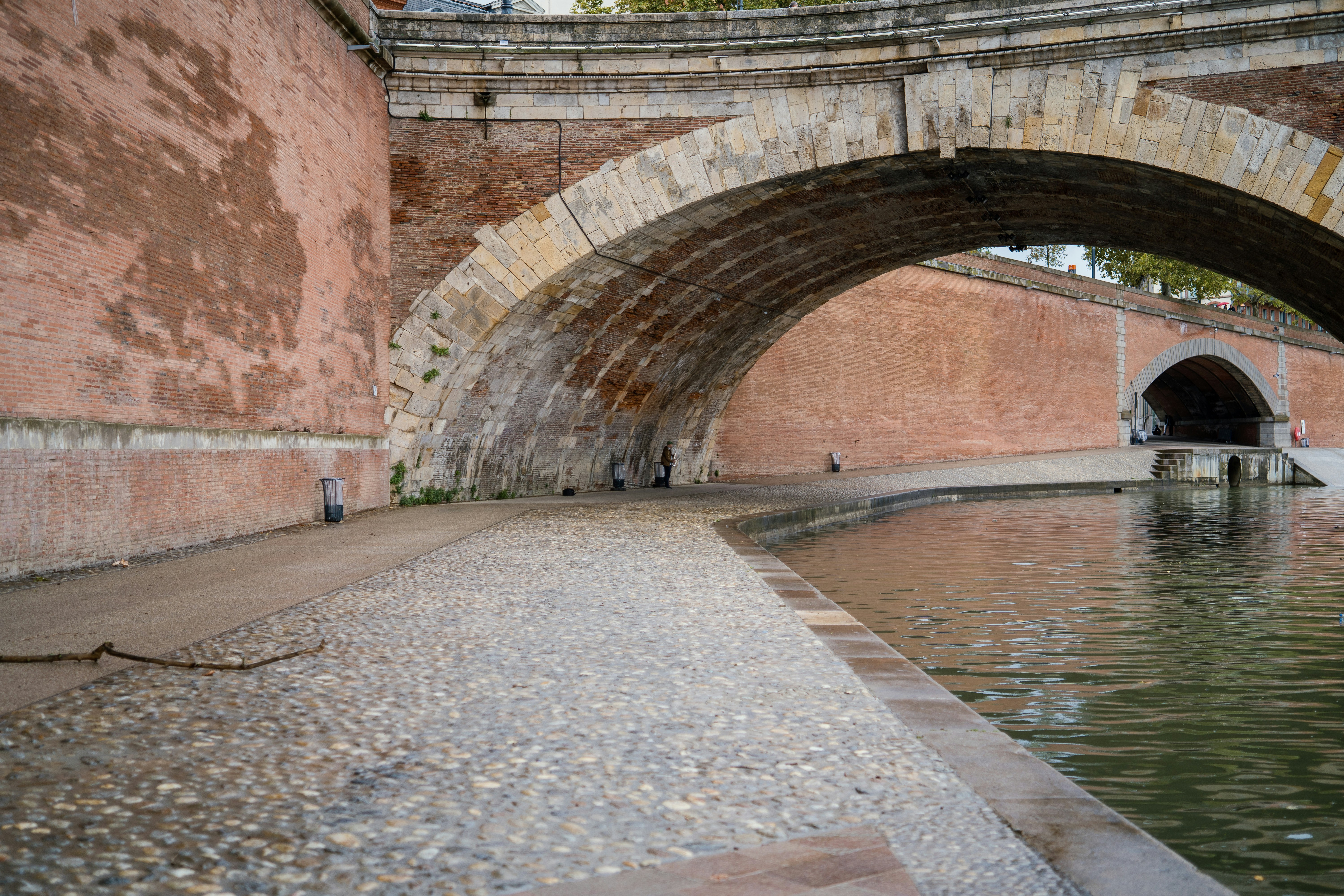 Brick Archway Over a Quiet Canal Walk