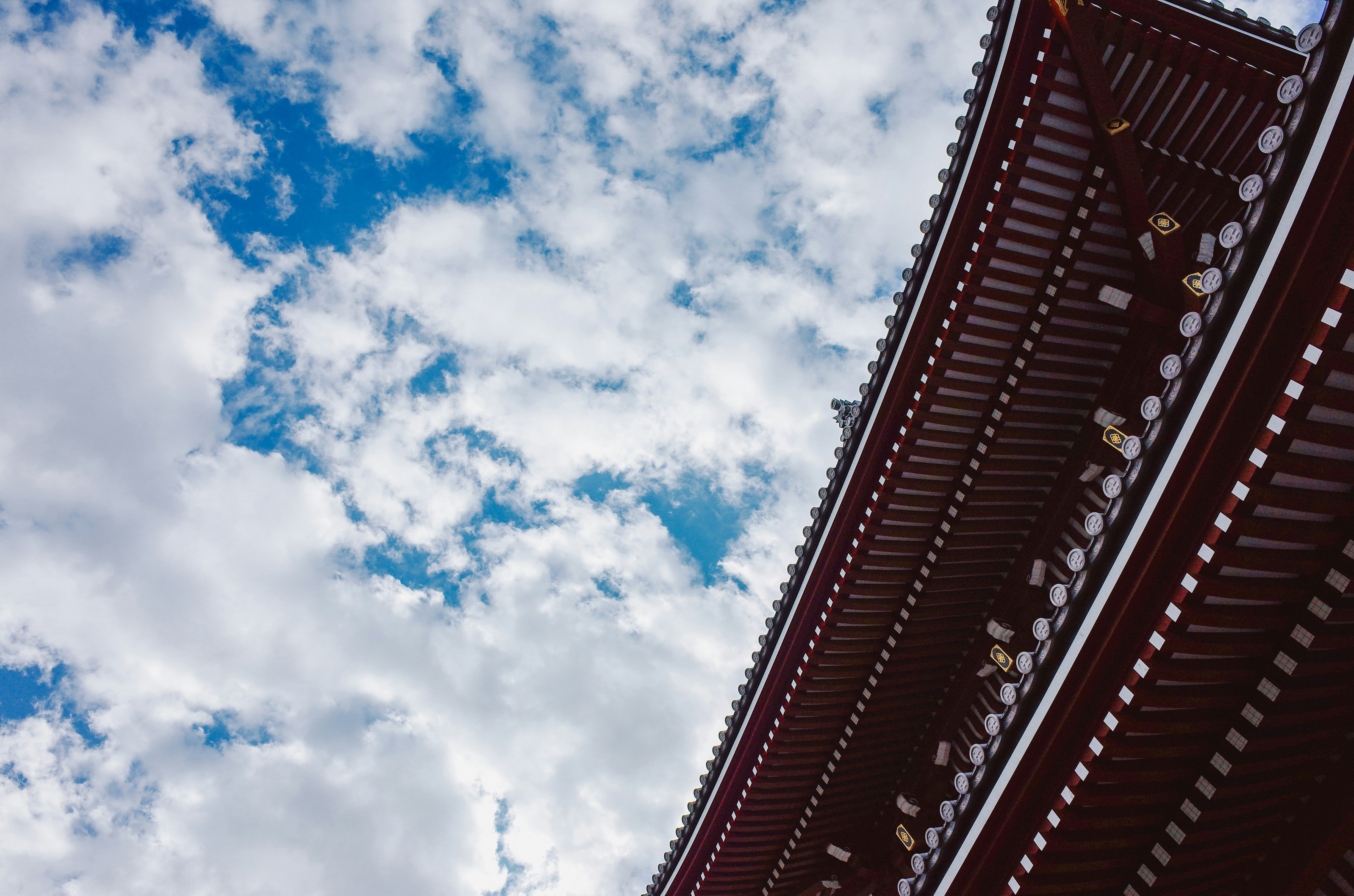 Hidden Skyline Slope: Cornered Temple Eaves Against a Bluestone Sky