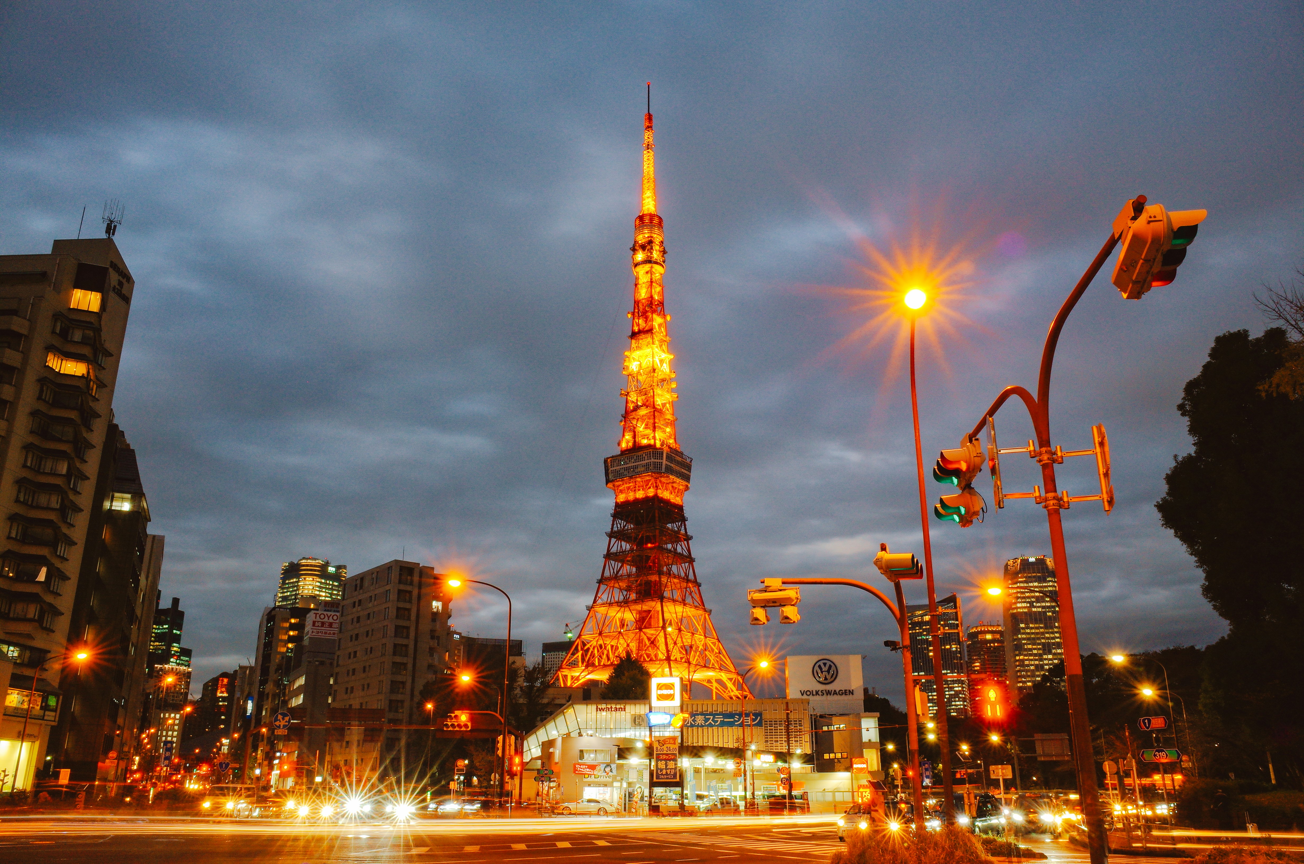 Tokyo Tower illuminates a city of traffic and twilight