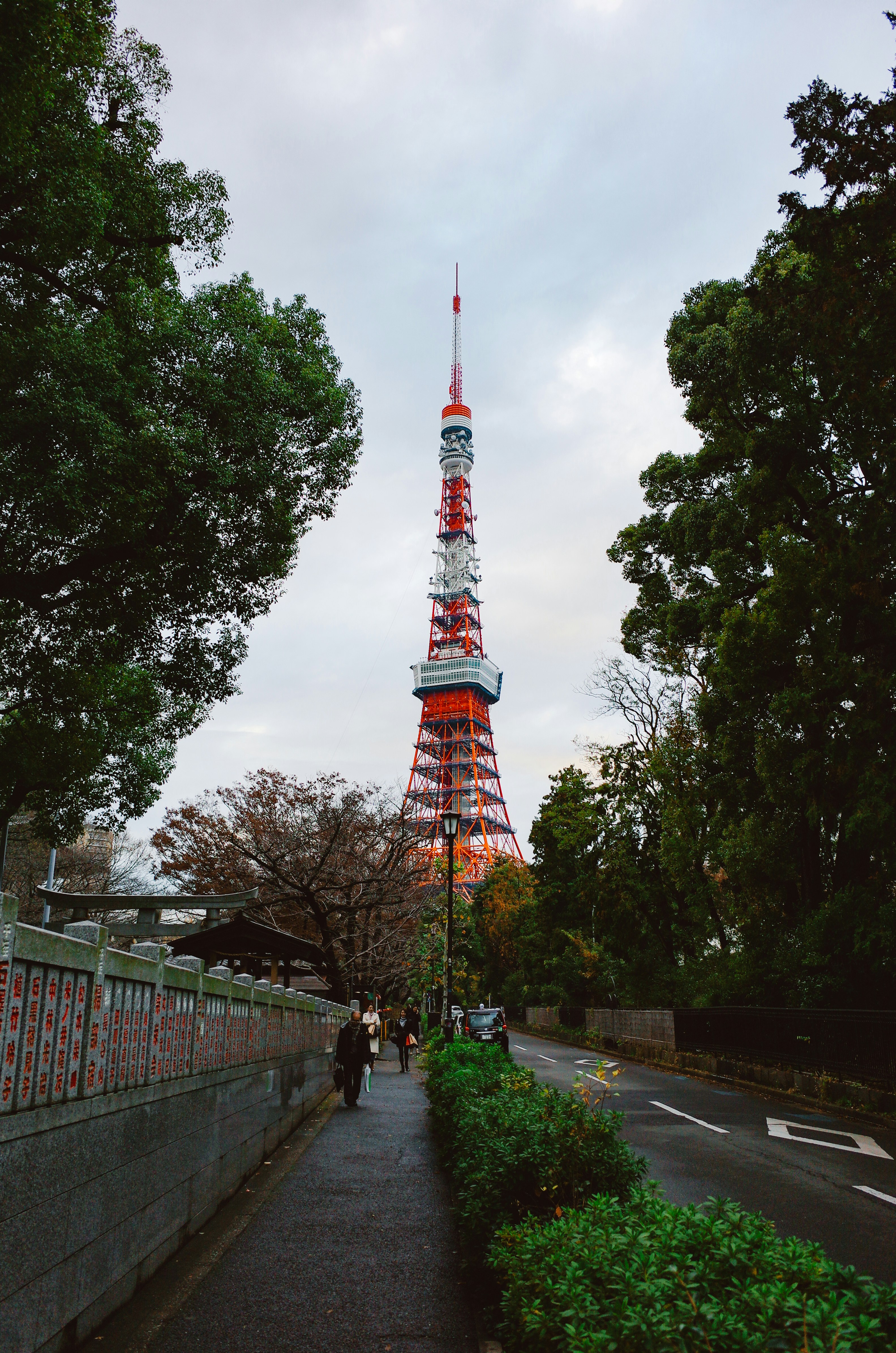Towering Signal: Tokyo Tower Looms Over a Quiet Path