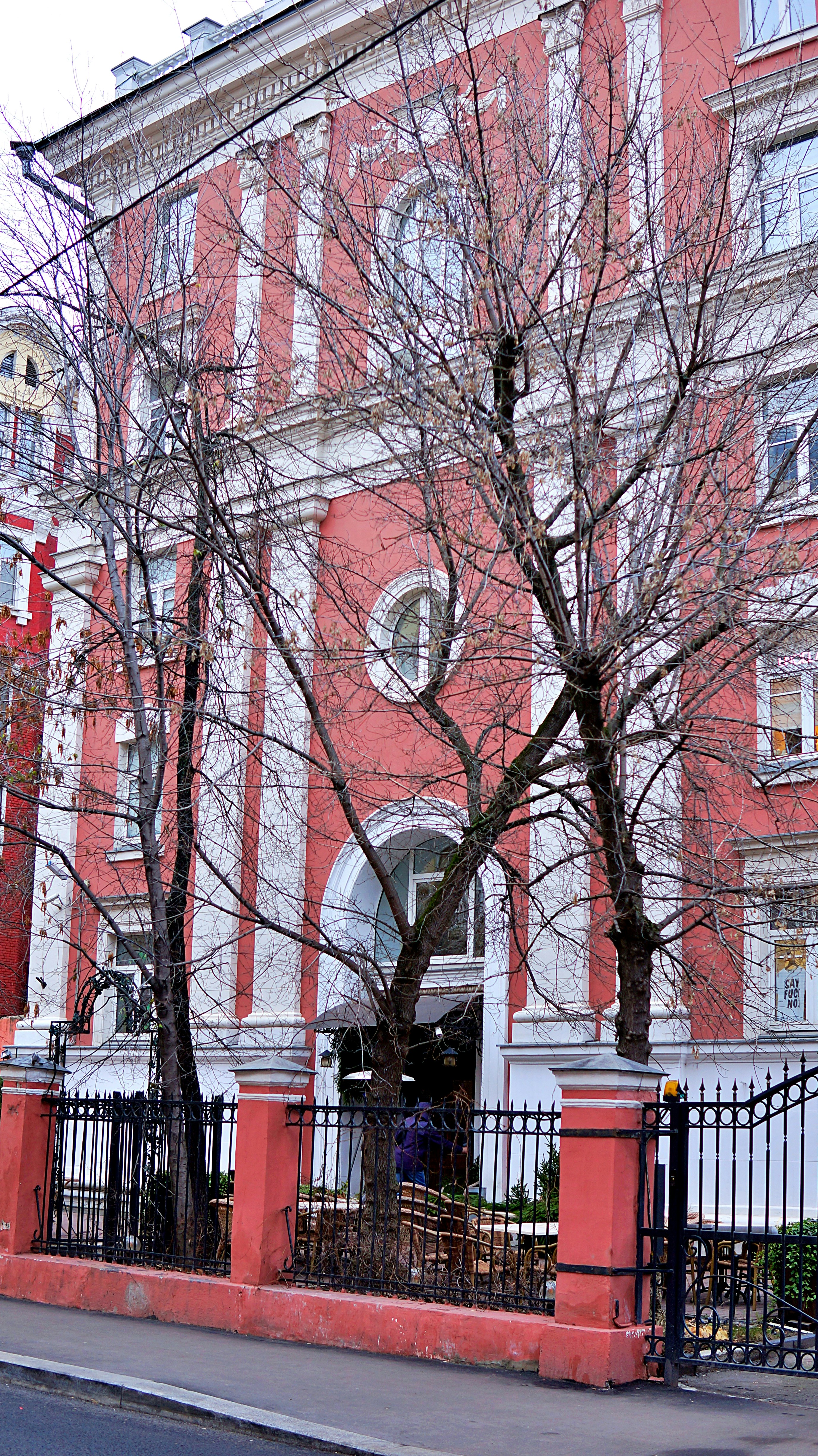 Fiery red Facade Framed by Winter Trees