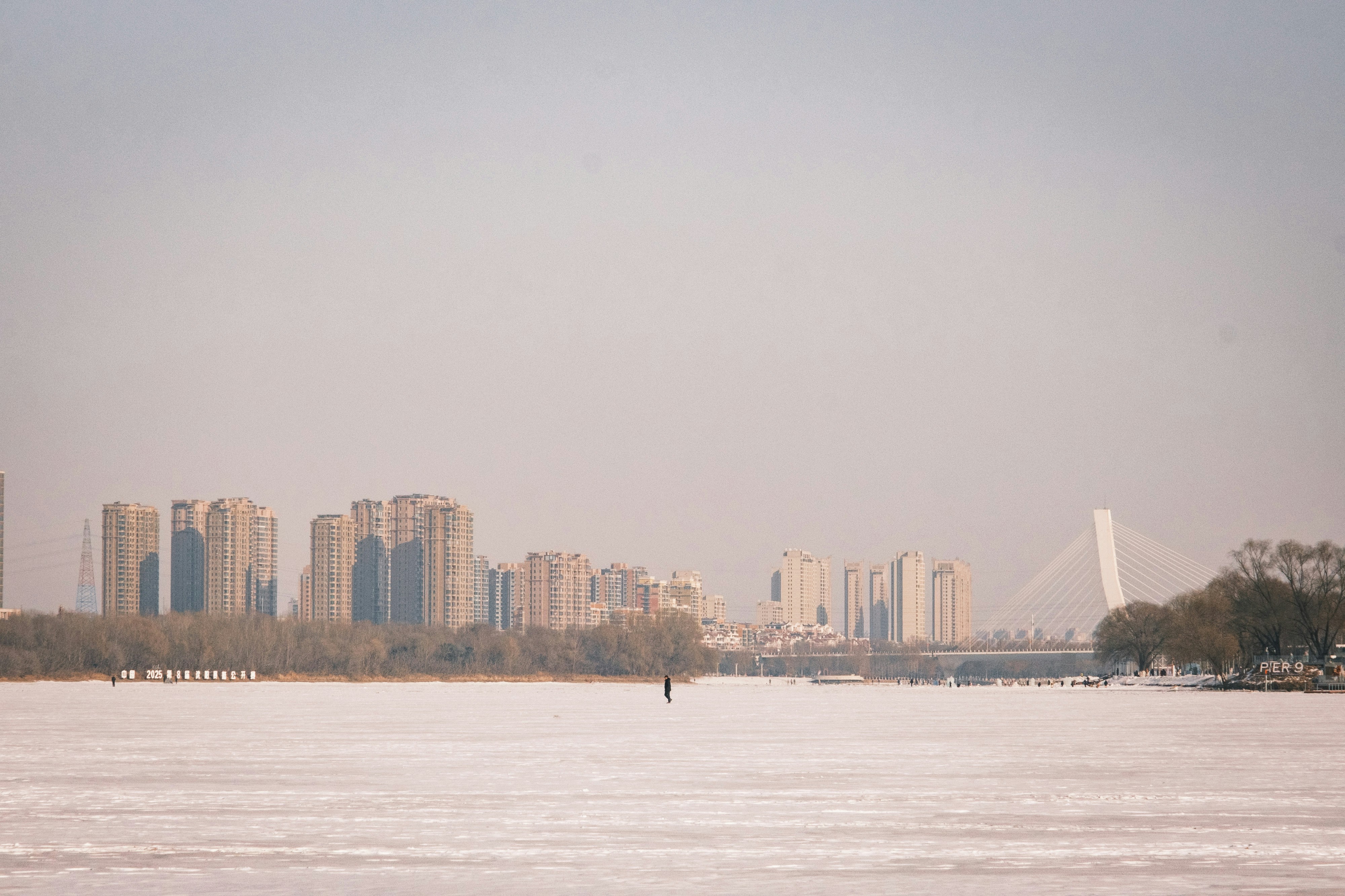 Winter Cityline Across a Snow-Cut River