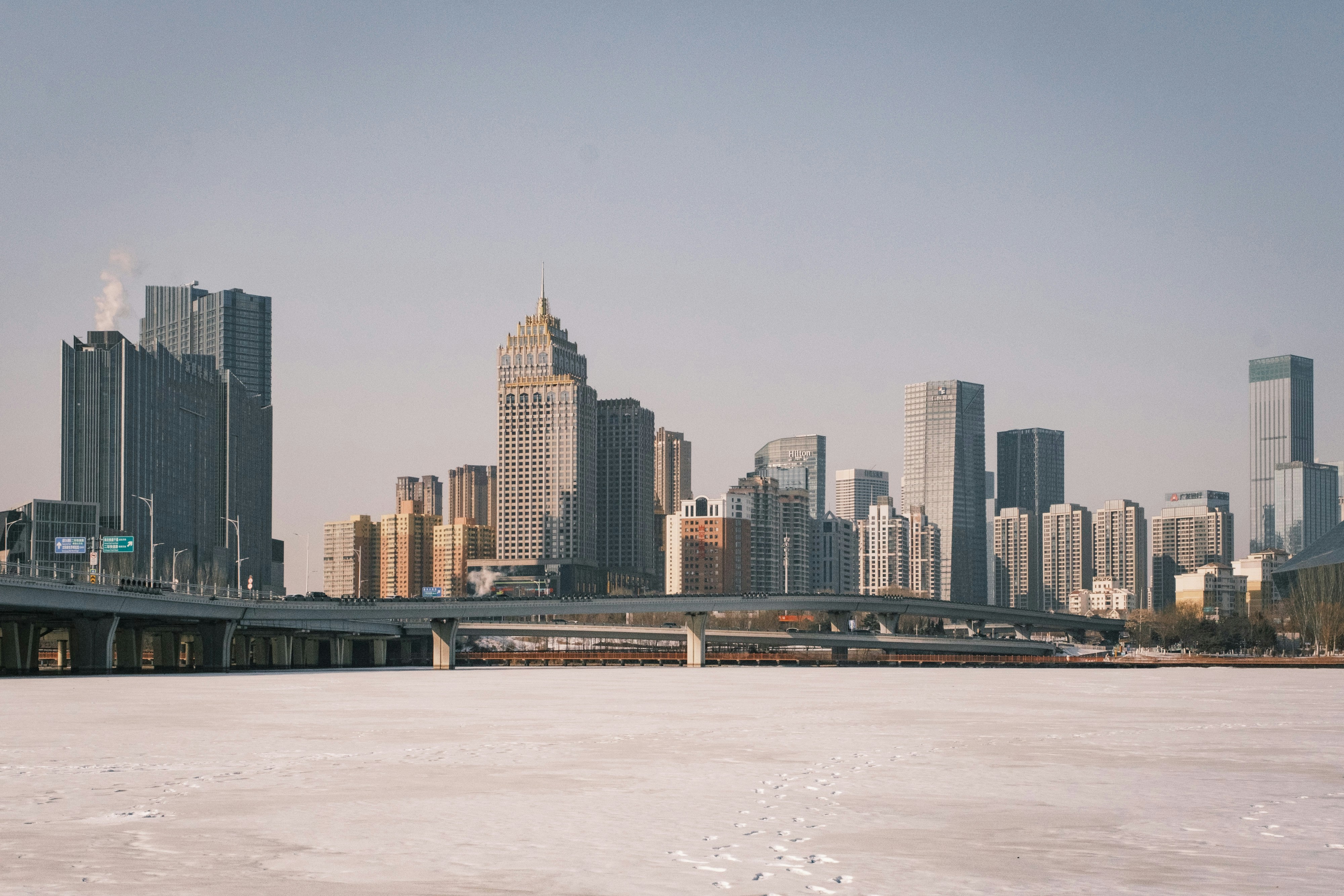 Dawn Over the Ice‑Touched River: City Silhouette Rising