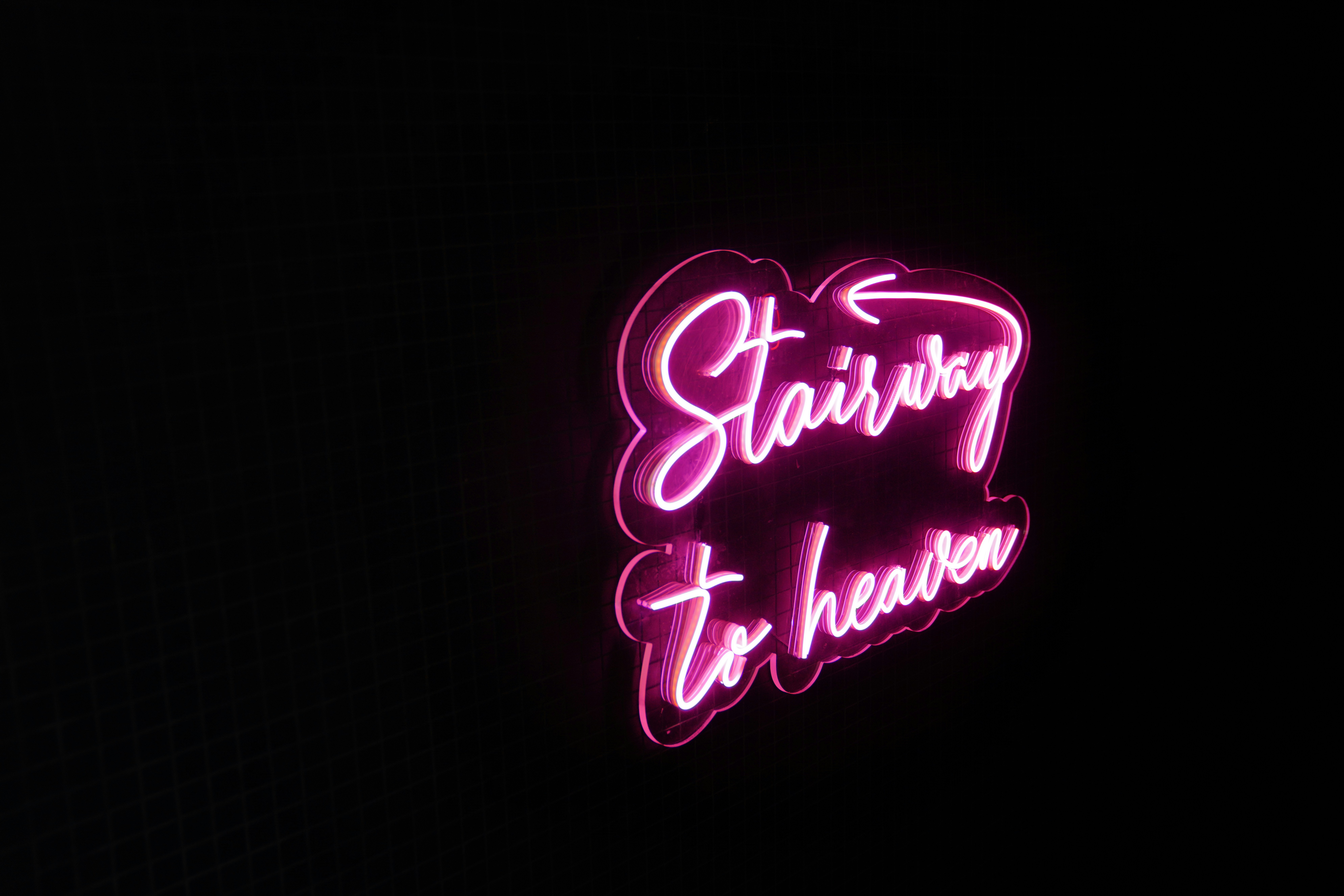 Neon Stairway to Heaven: A Pink Sign Illuminates the Dark