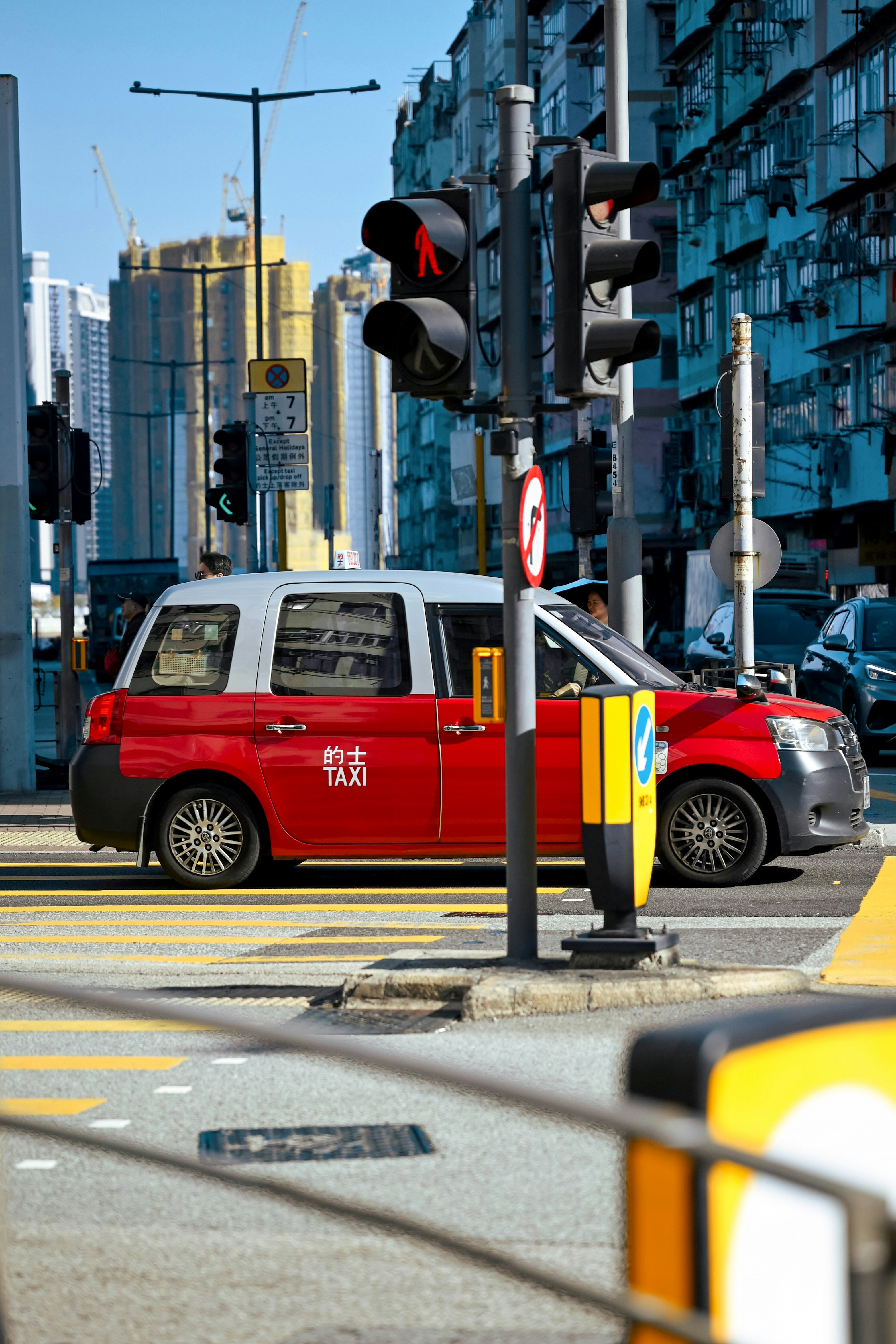 Red Taxi at a Busy Urban Intersection