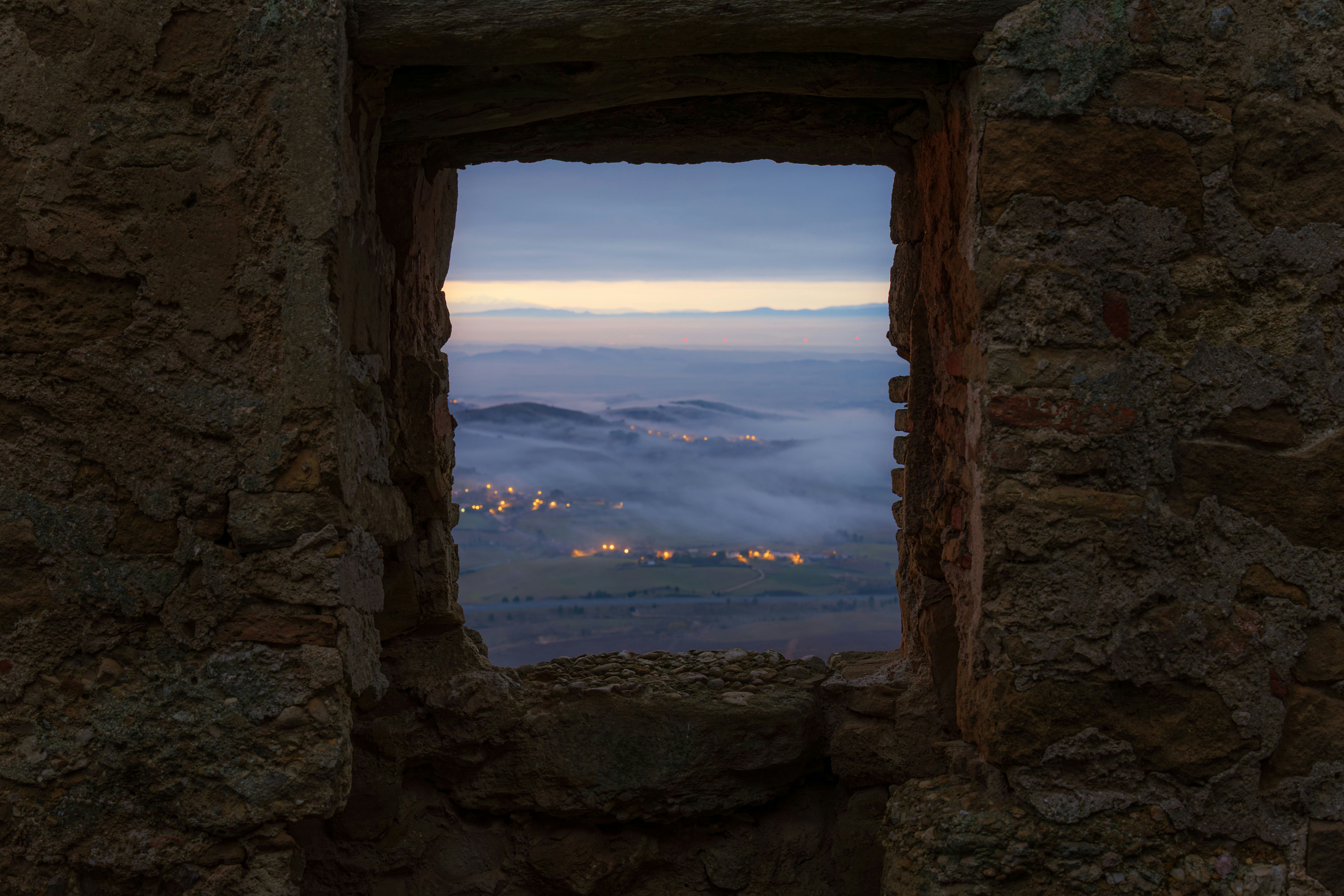 Stone Window to Distant Lights and Mist