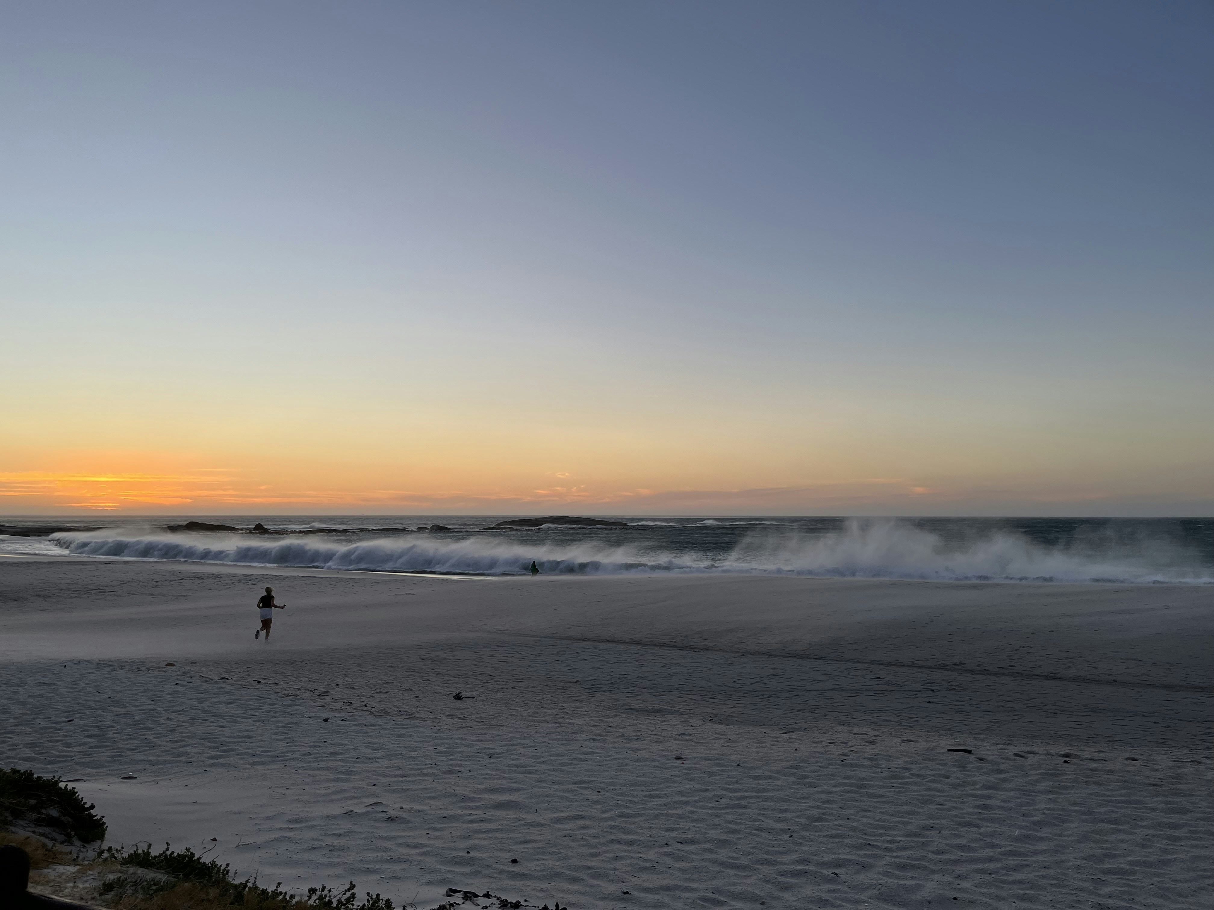 Dune Runner at Dusk: A Lone Figure Guards the Quiet Shore
