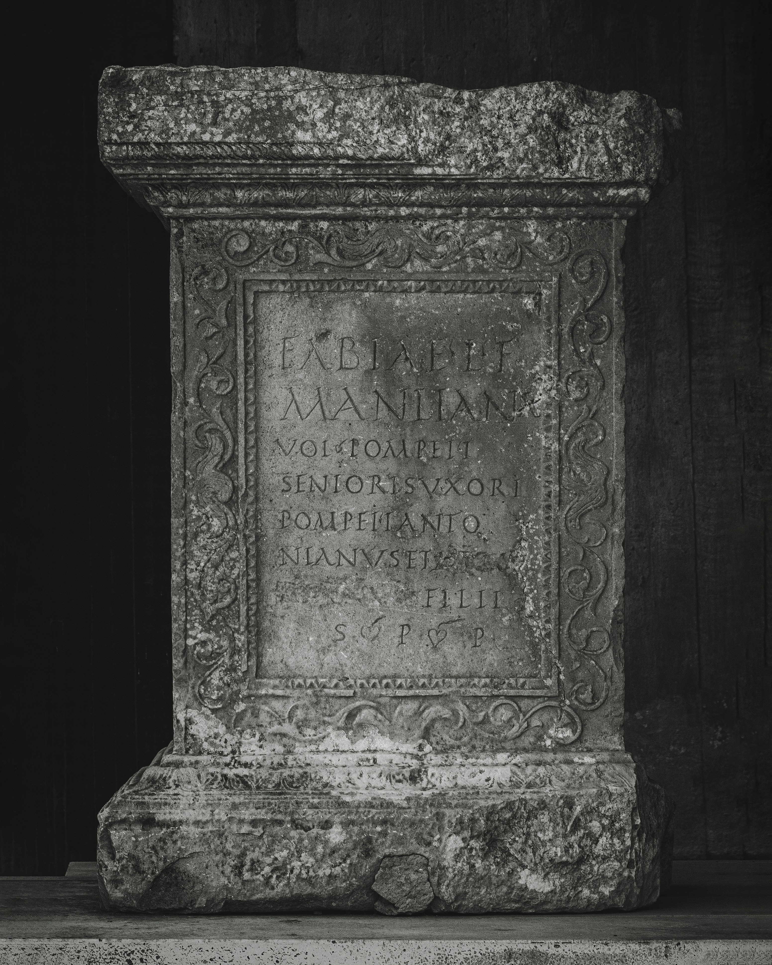 Weathered Stone Tablet: Inscribed Monument in Dim Light
