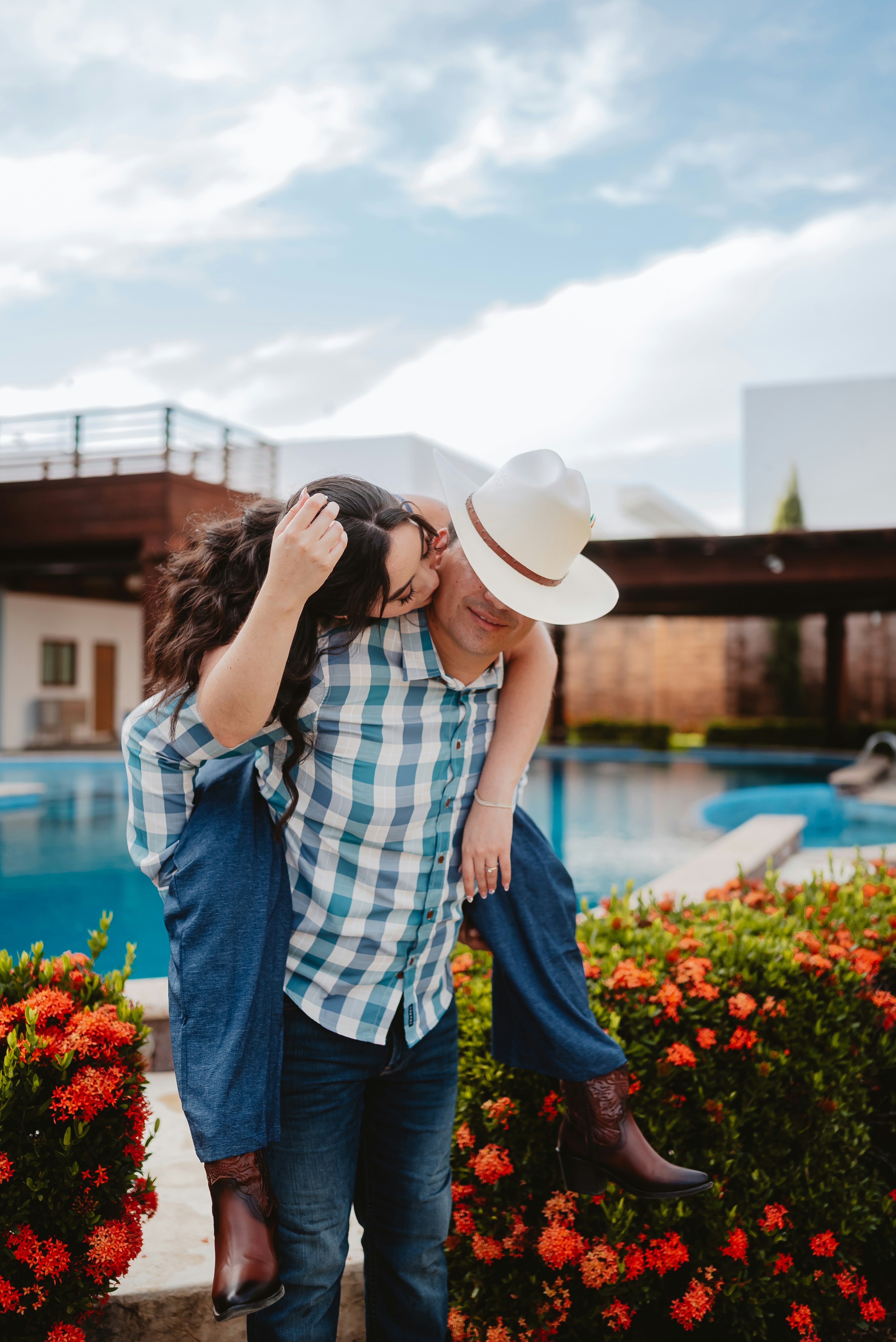 Partners in laughter by the poolside embrace