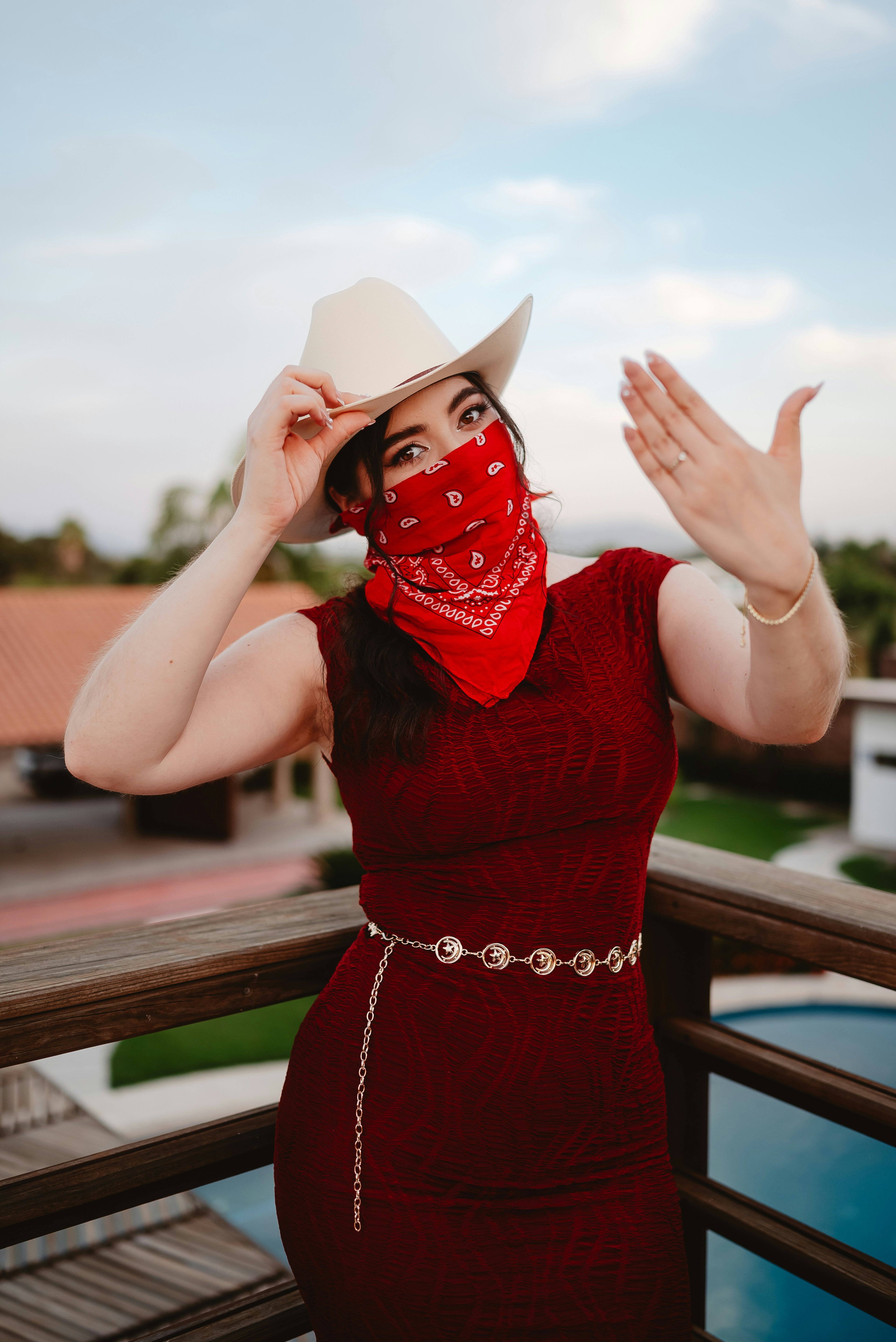 Red Bandana, White Hat, and Rose-Color Confidence on a Balcony