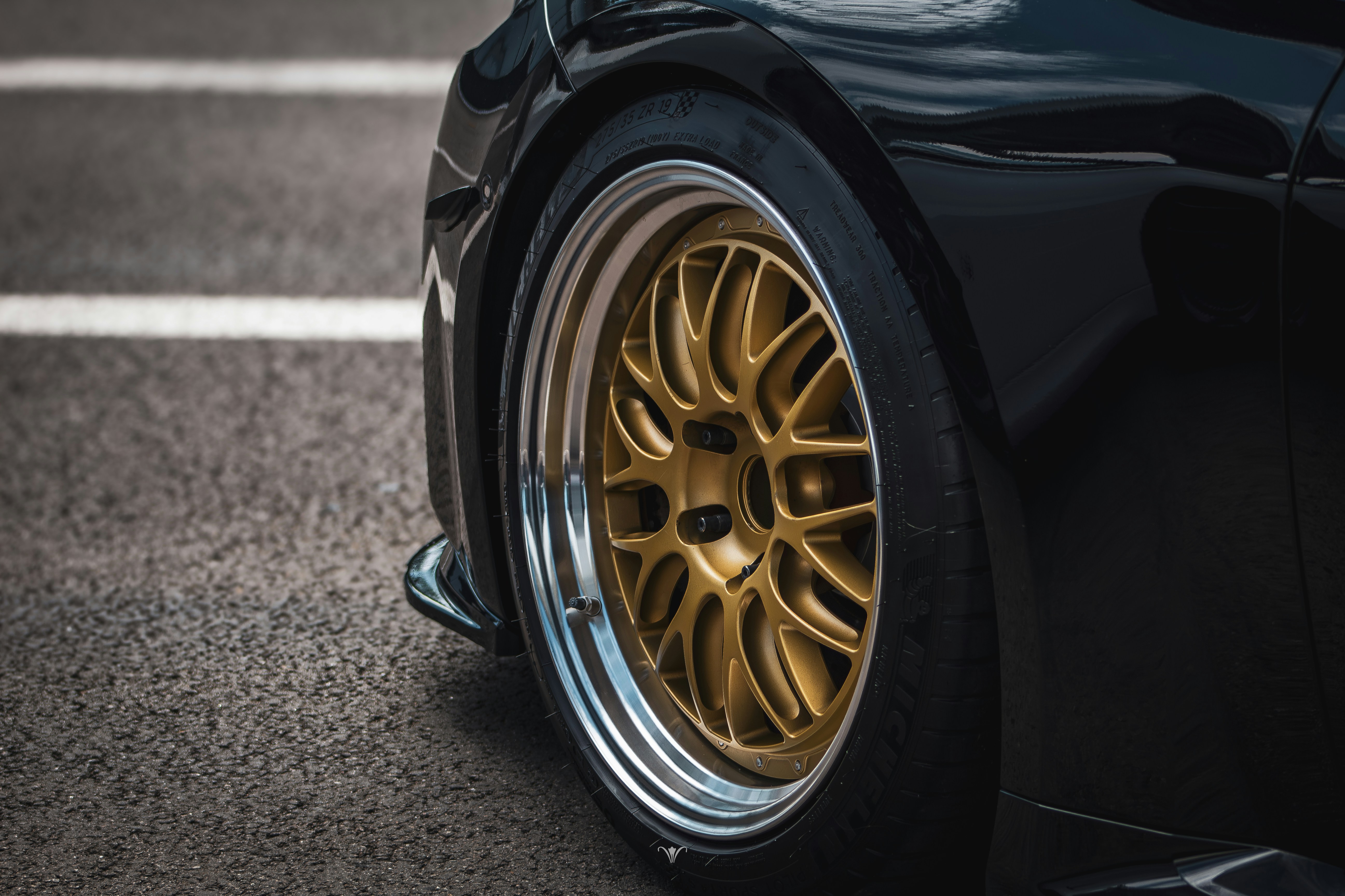 Golden spokes and chrome rim: a close-up on racing aesthetics