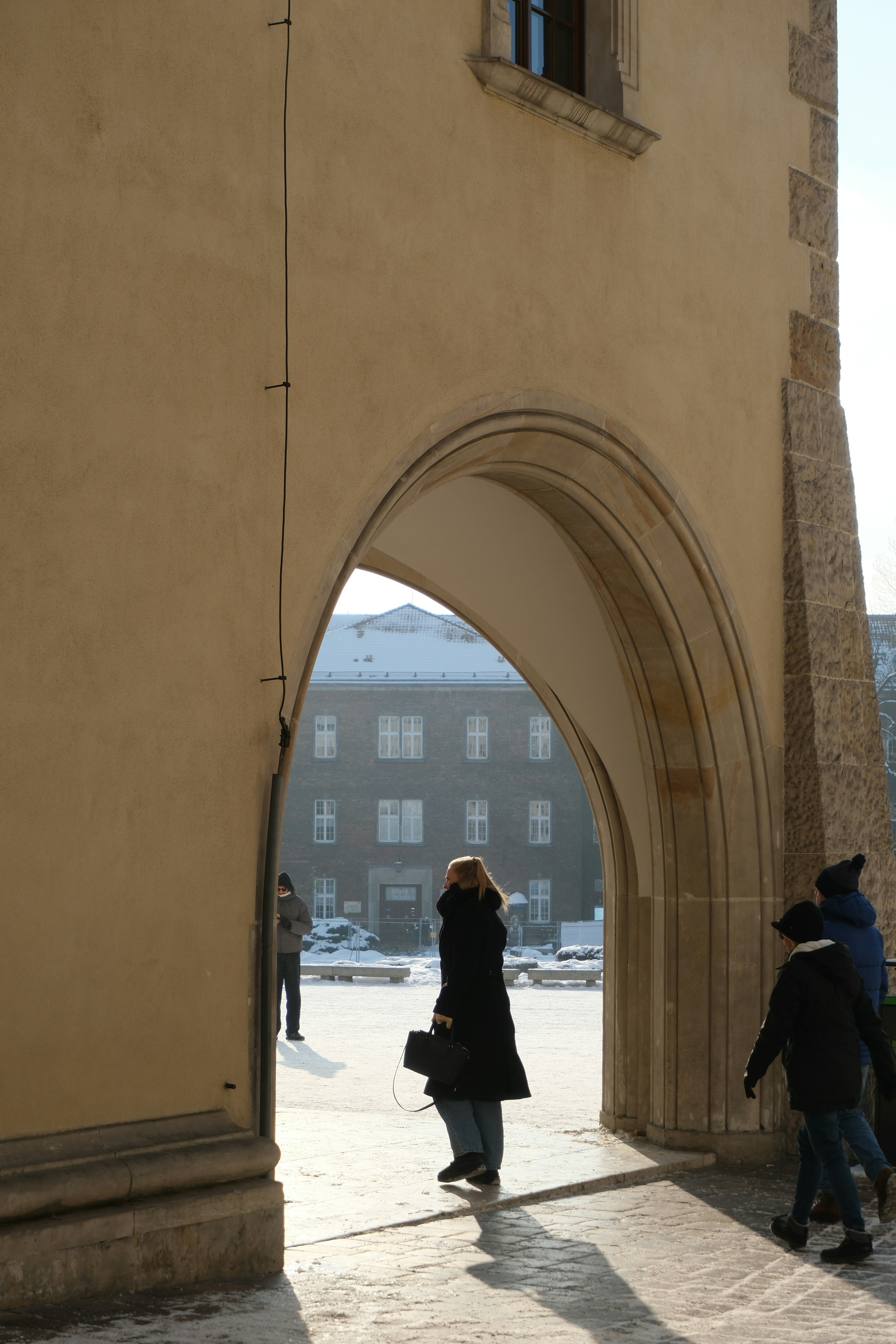 Through the Archway: A Quiet Winter Moment in the Courtyard