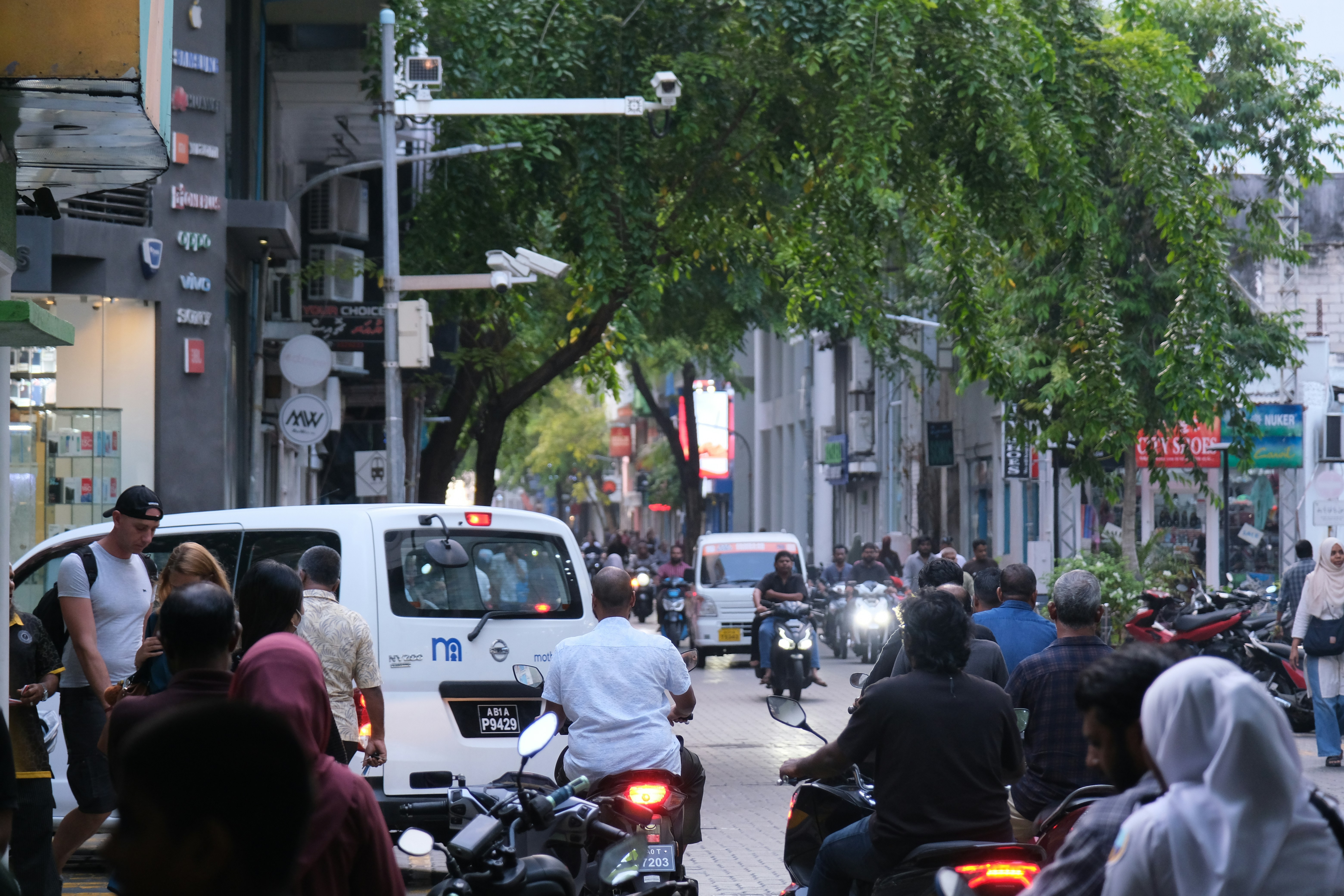 Crowded City Street: A Busier Horizon of Motorbikes and Pedestrians