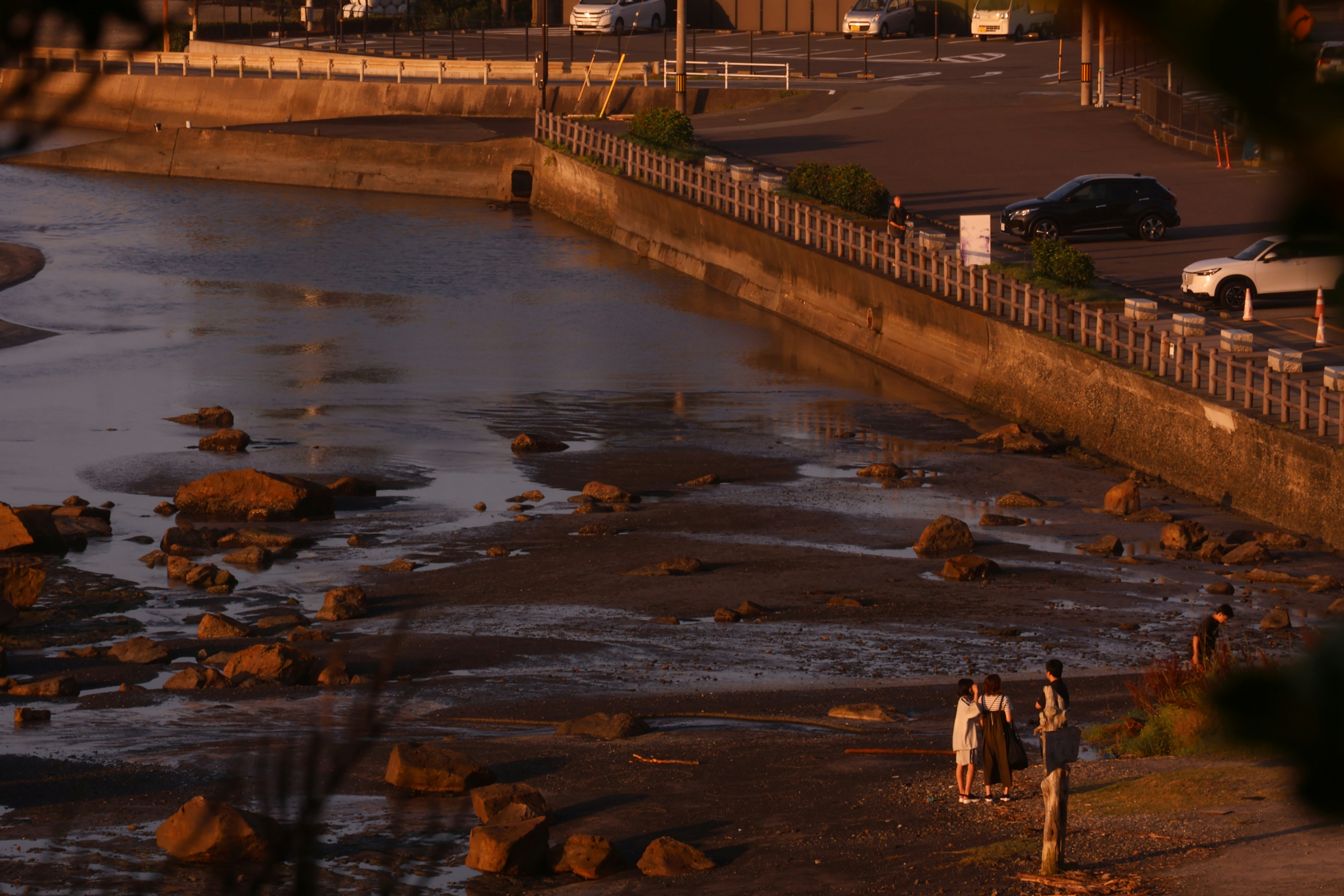 Evening Life Along the Riverbank: People by the Water