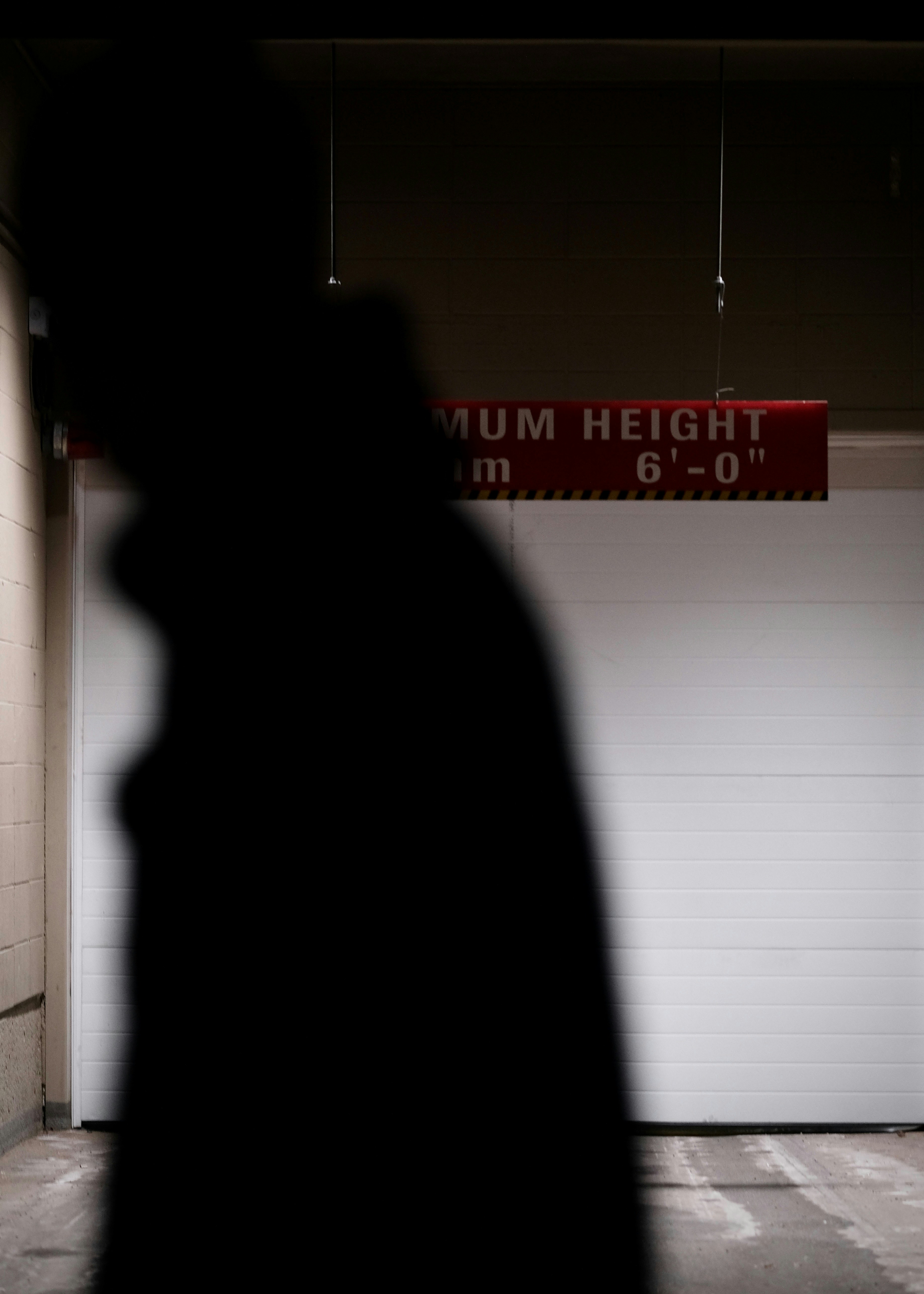 Shadowed Figure in an Industrial Hallway