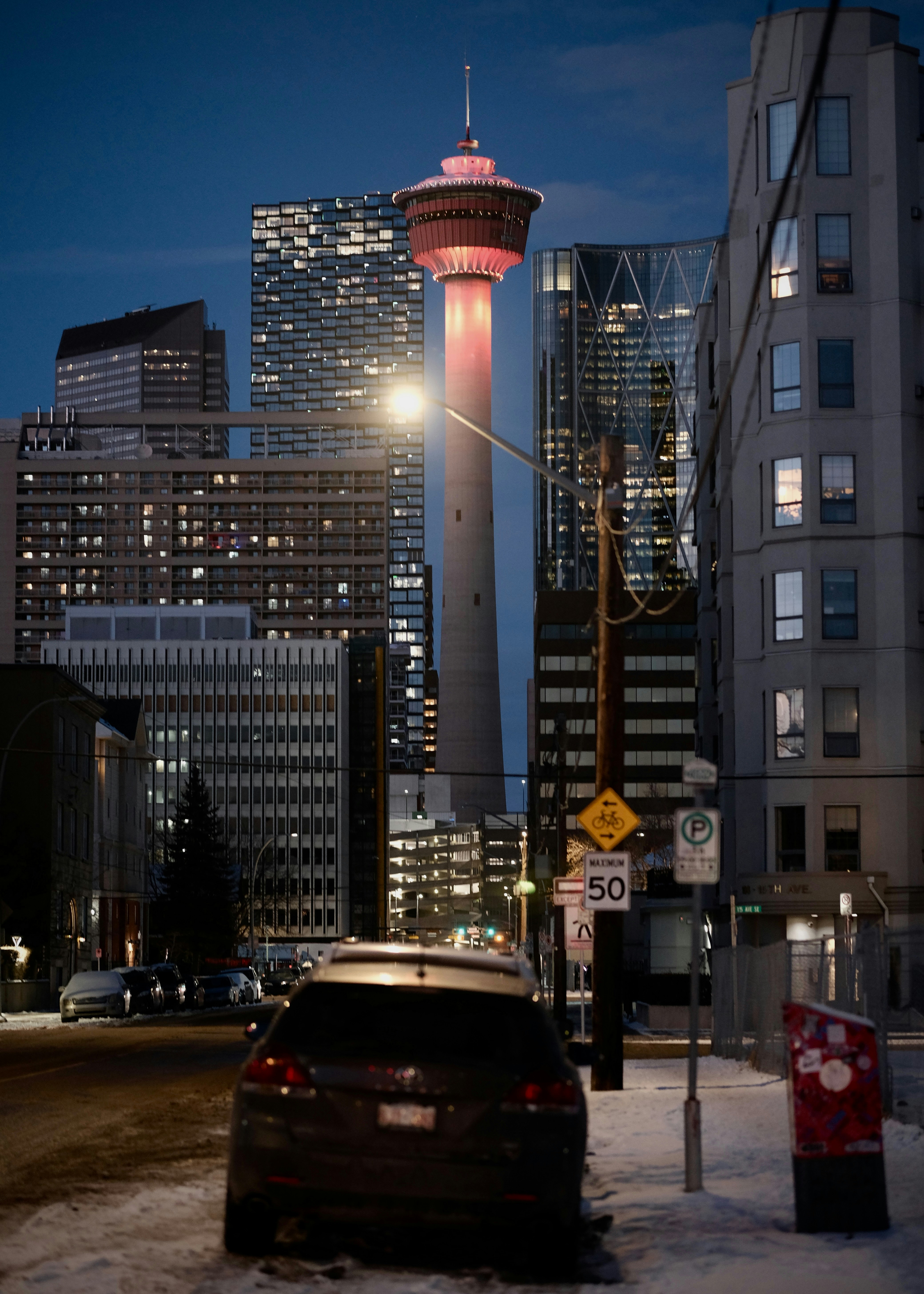 City Tower at Dusk: Neon Pillar among Glass and Snow