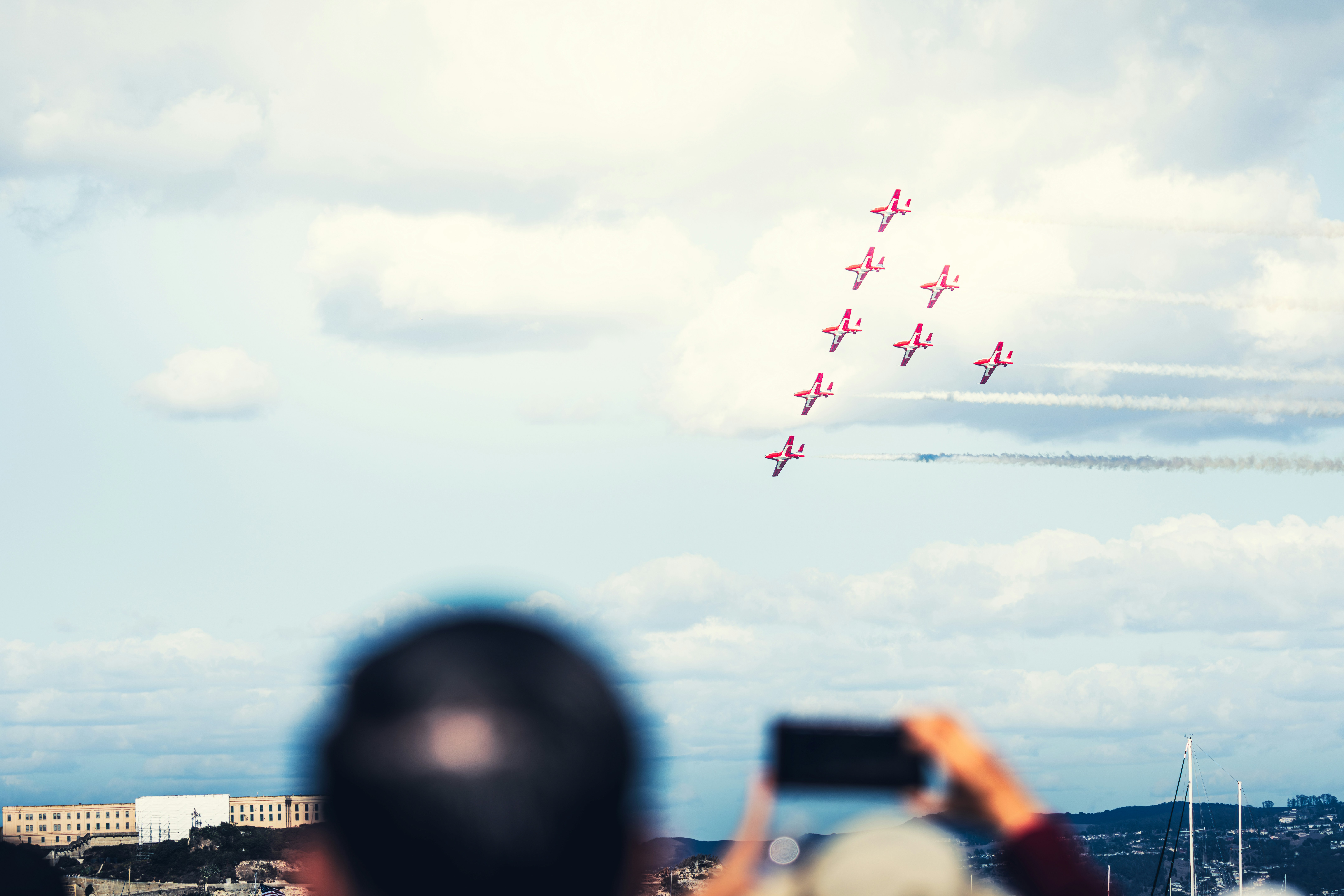 Aerial Assembly: Precision Flyover Over a Blurred Crowd
