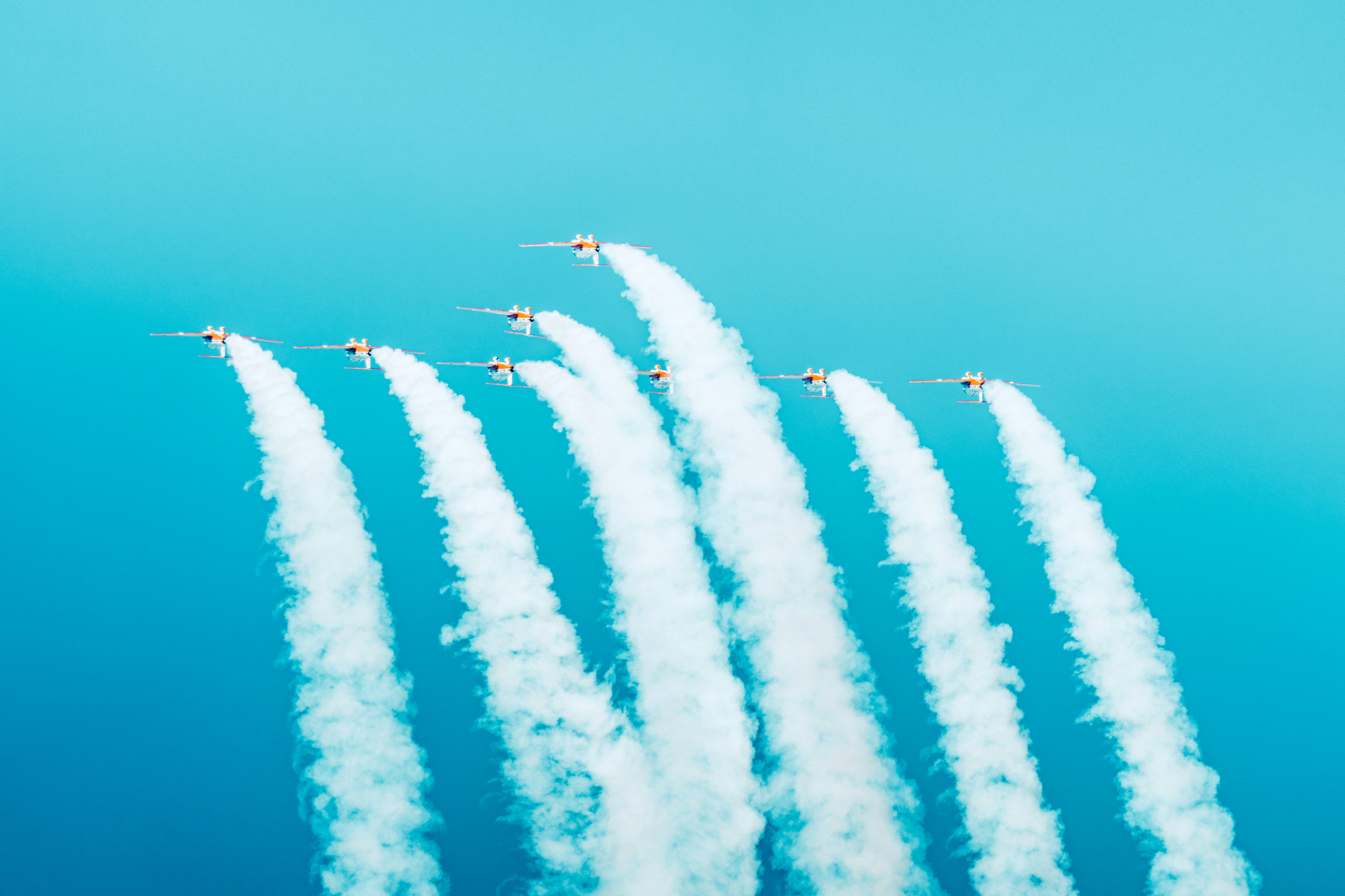 V‑Formation Contrails: Aerial Parade Across a Cerulean Sky