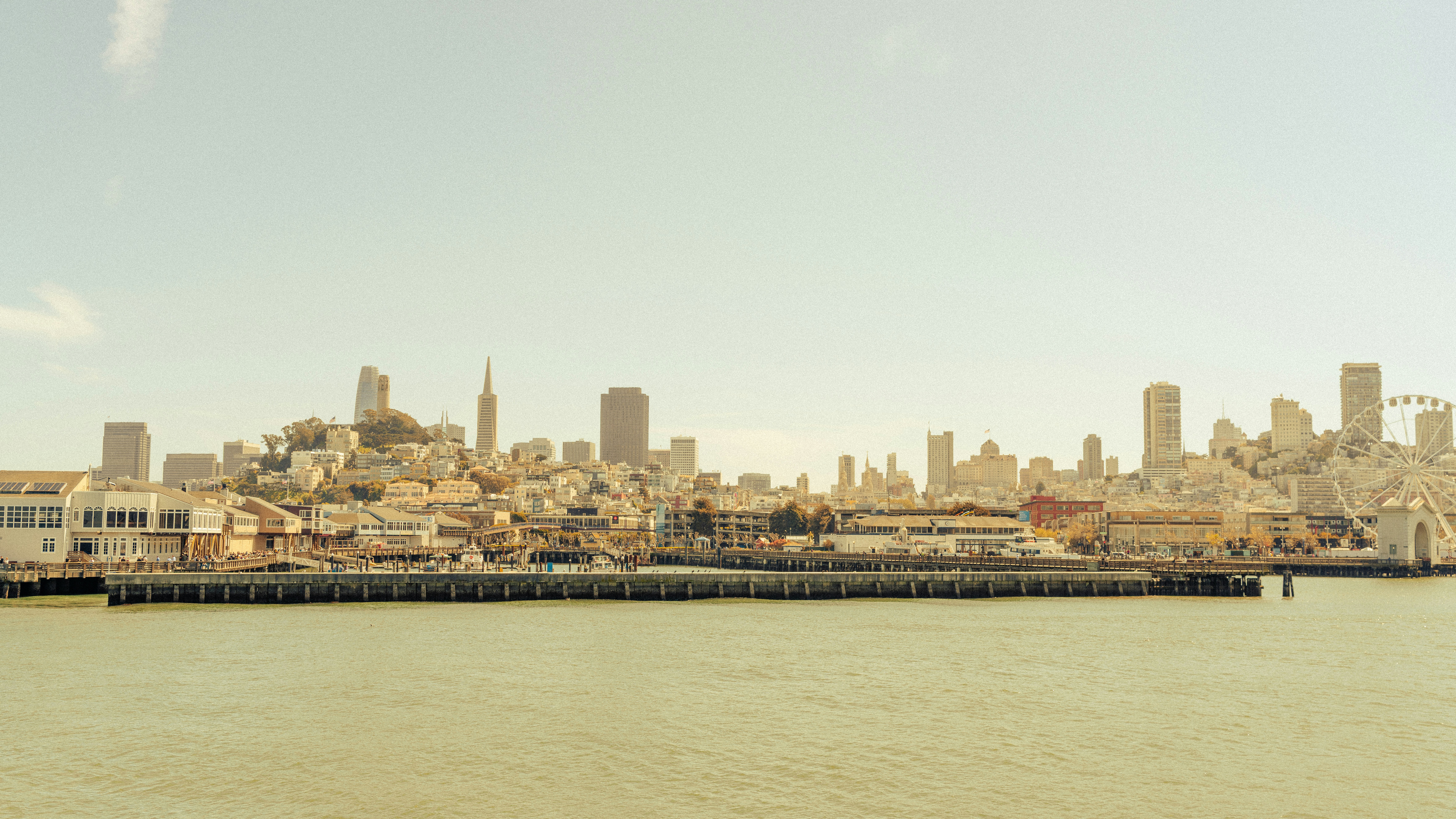 Harbor Skyline: Golden-Tone City Across Gentle Waves