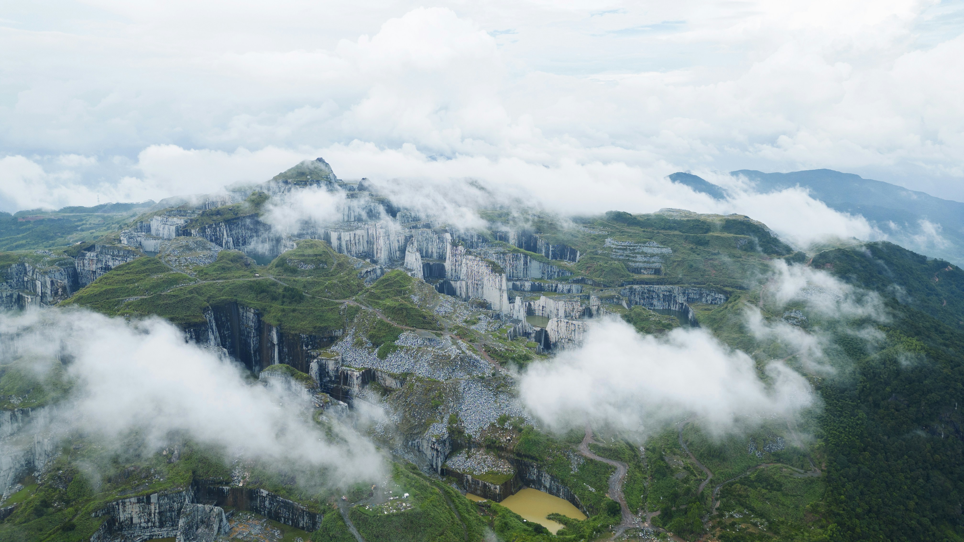 Misty Ridge: Aerial View of Cliffed Plateau Shrouded in Clouds