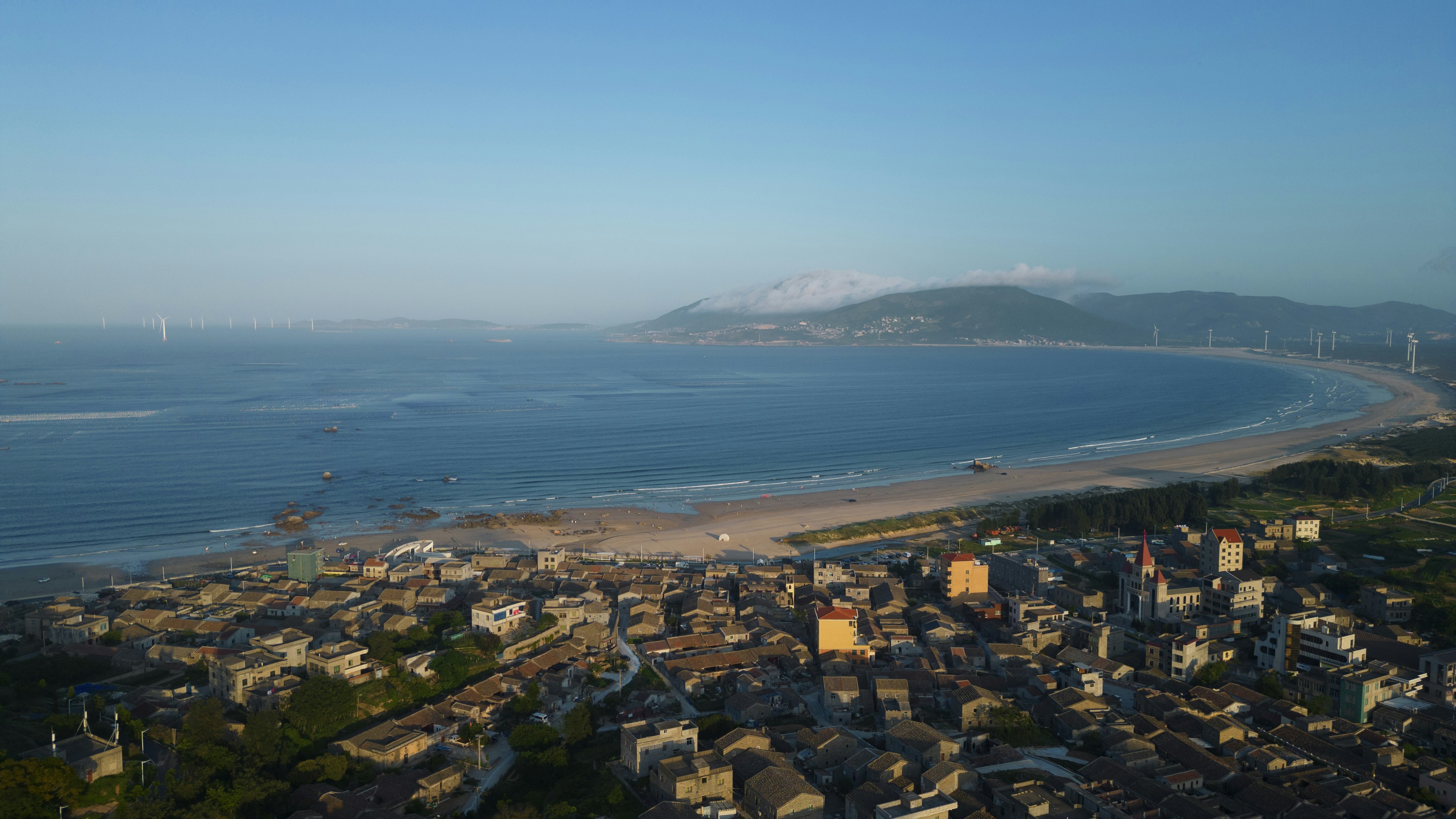 Coastal Suburbward Horizon: Aerial View of Beachfront Town