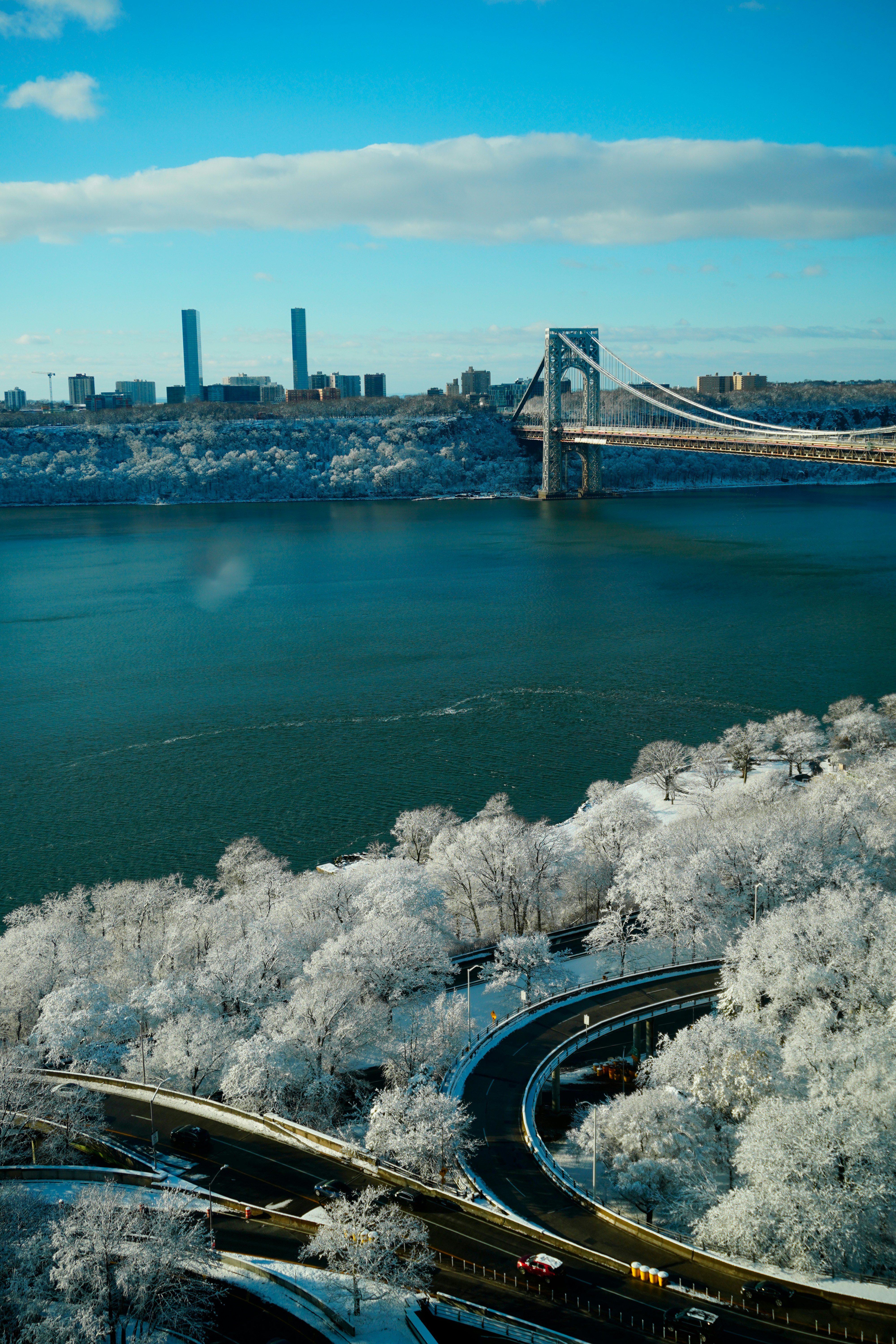 Winter River Overlook: Frosted Trees, Cable Bridge, and Coiled Roads