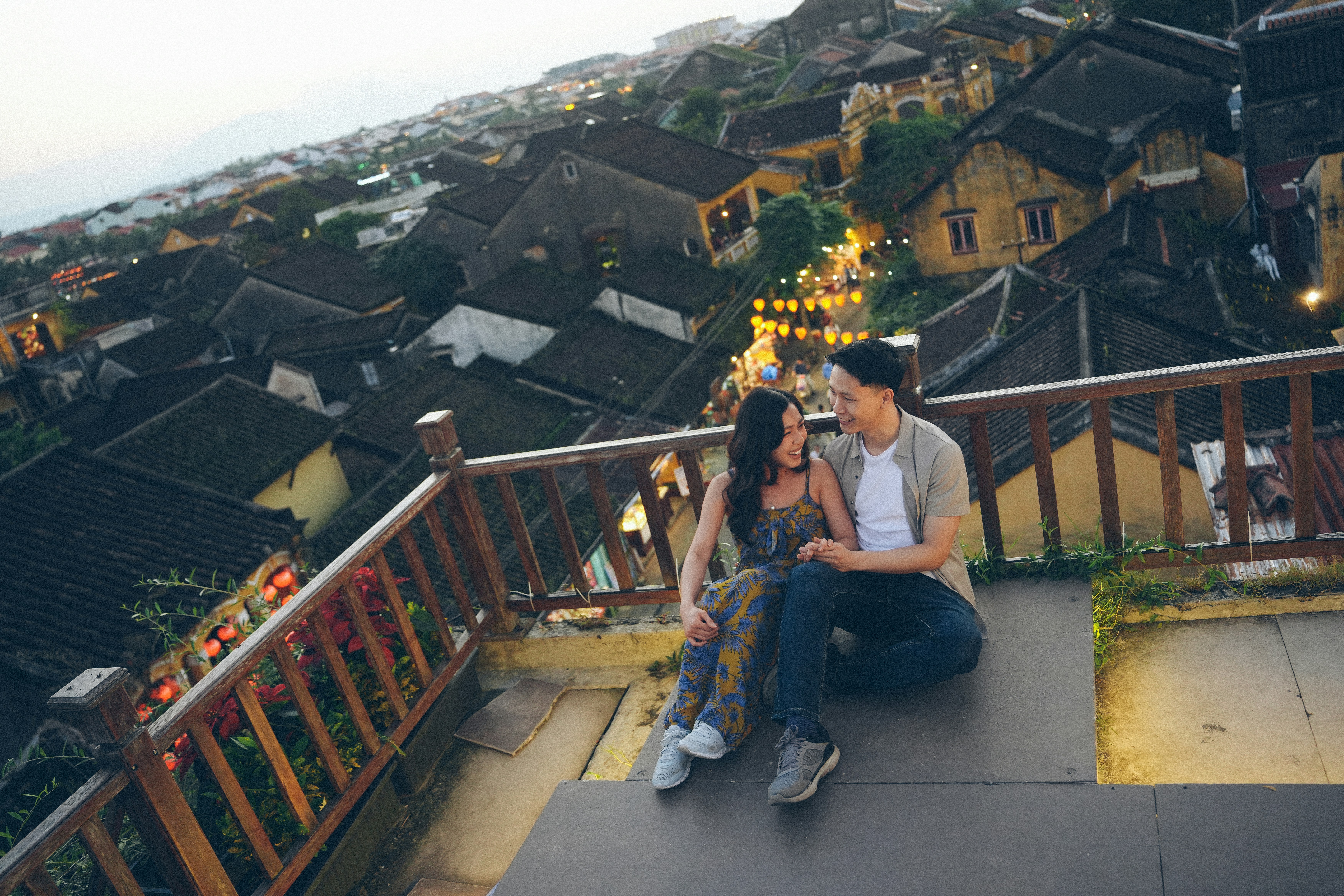 Couple on a Sunset Terrace Looking Over An Old Town