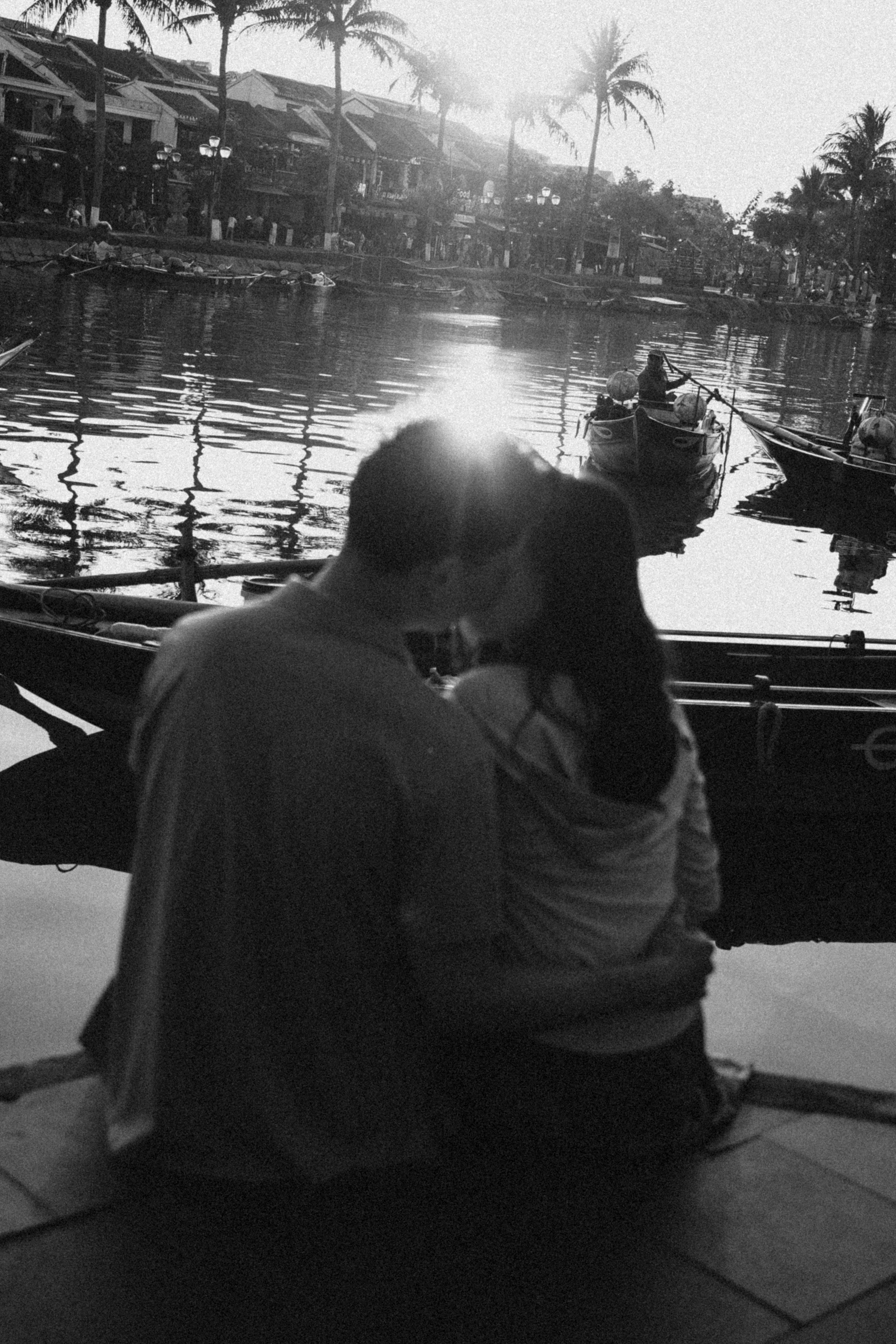 Moonlit kiss by the water: silhouettes in a tropical quay
