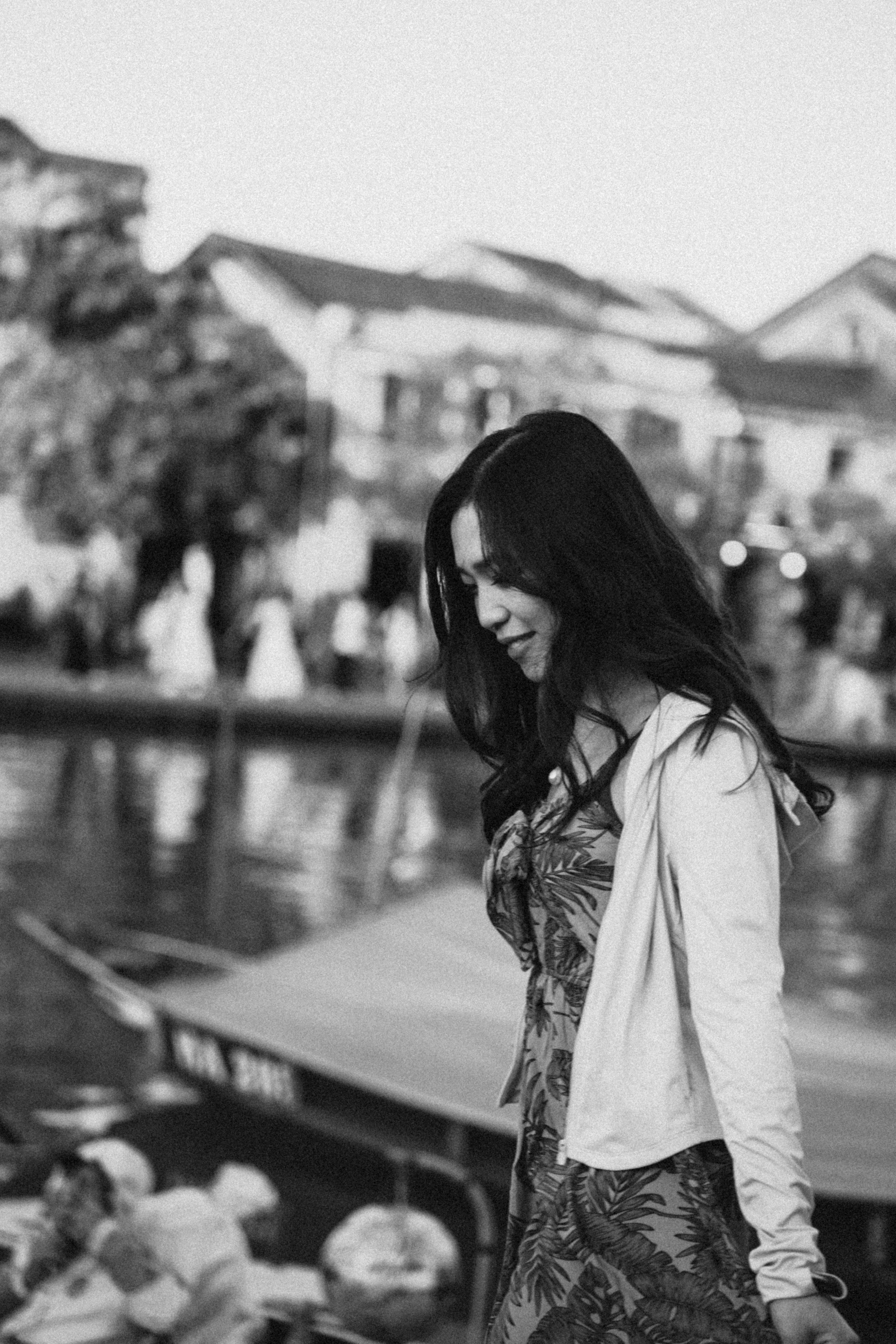 Soft silhouette of a woman beside a waterway