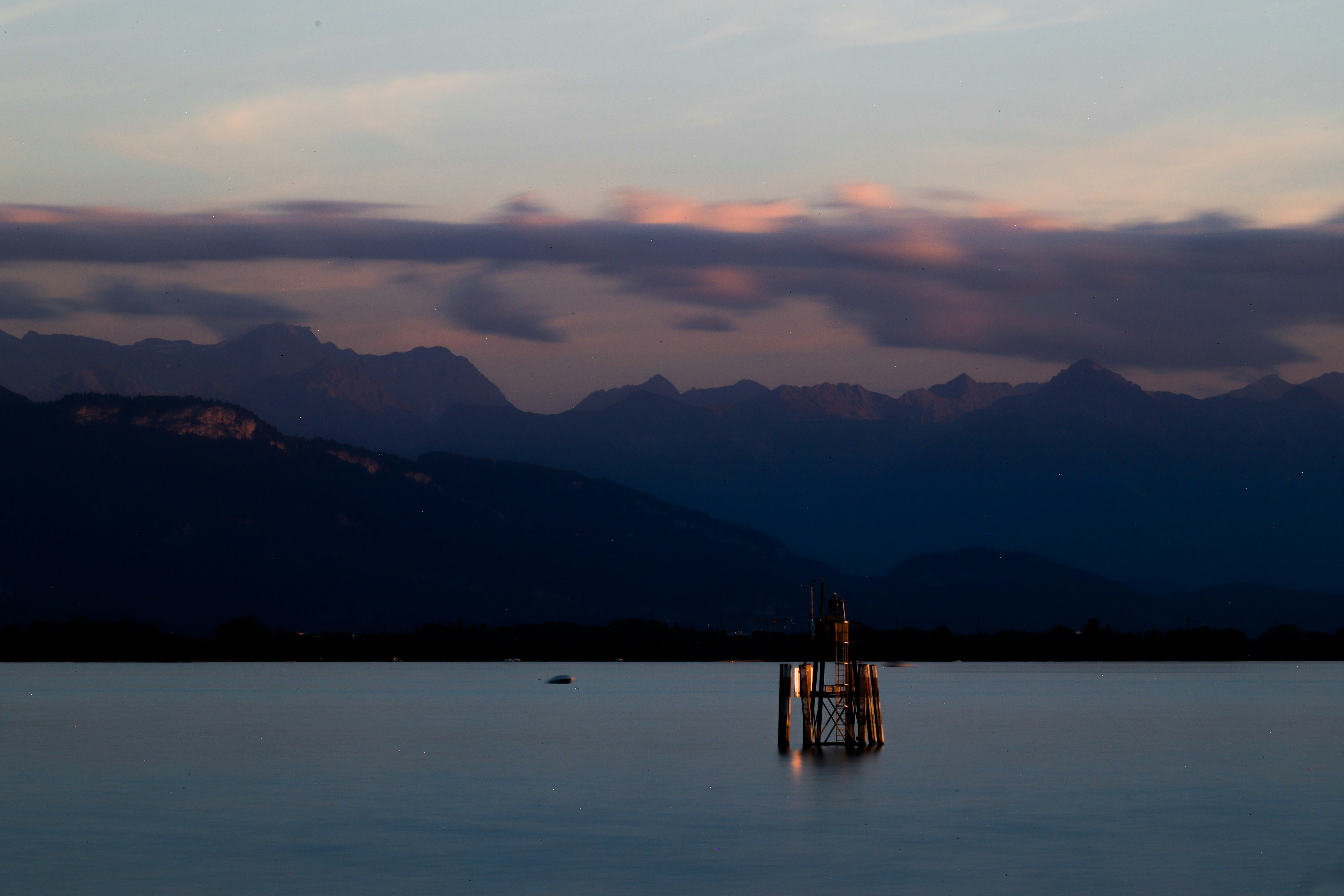 Distant Peaks at Dusk Over a Tranquil Pier