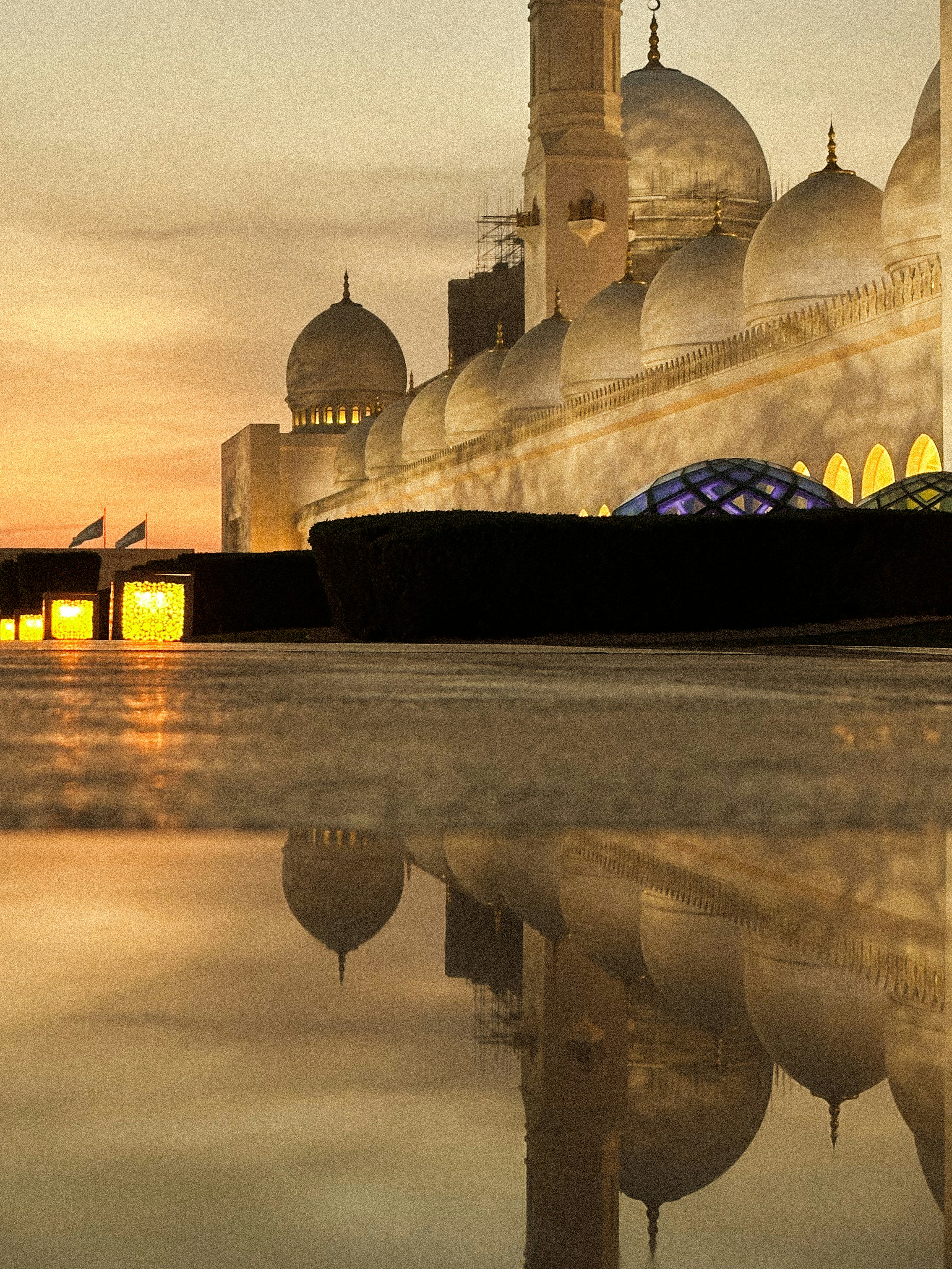 Dome silhouettes above a reflected marble foreground at dusk