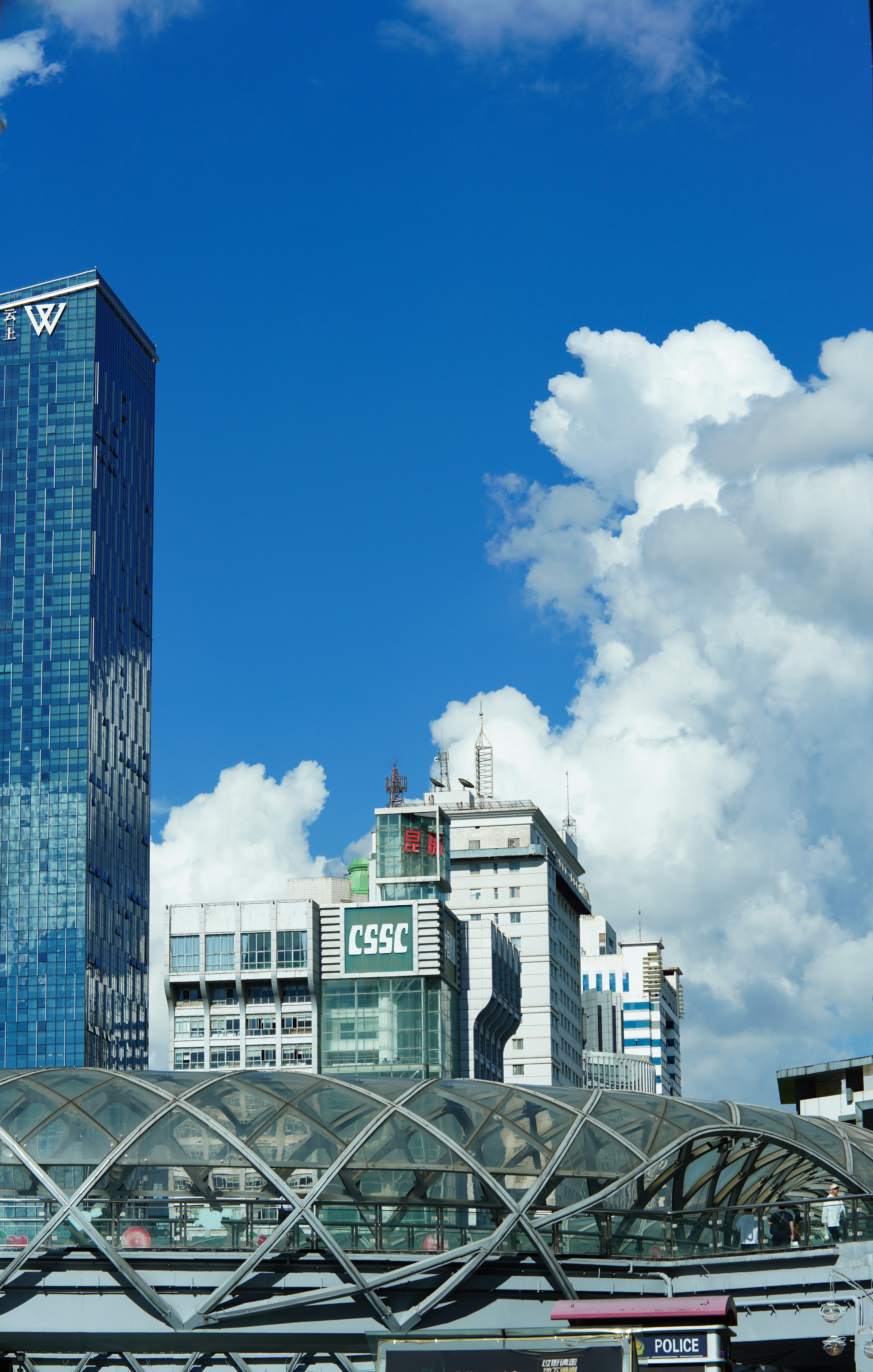 Skyline in Focus: A Glass Tower Reaching Toward a Bright Blue Day