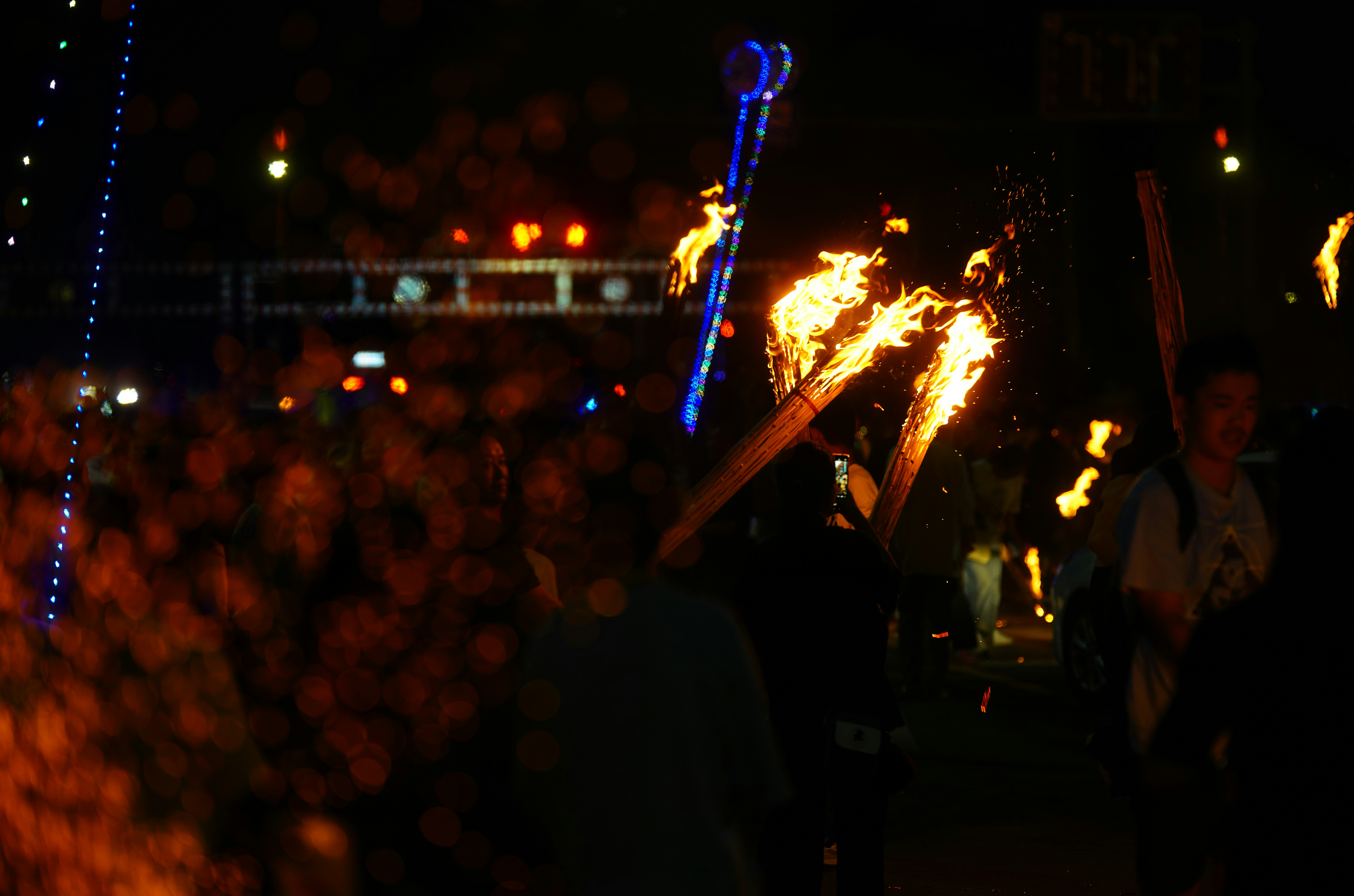 Trail of Fire: Torchbearers in a Night Street Parade