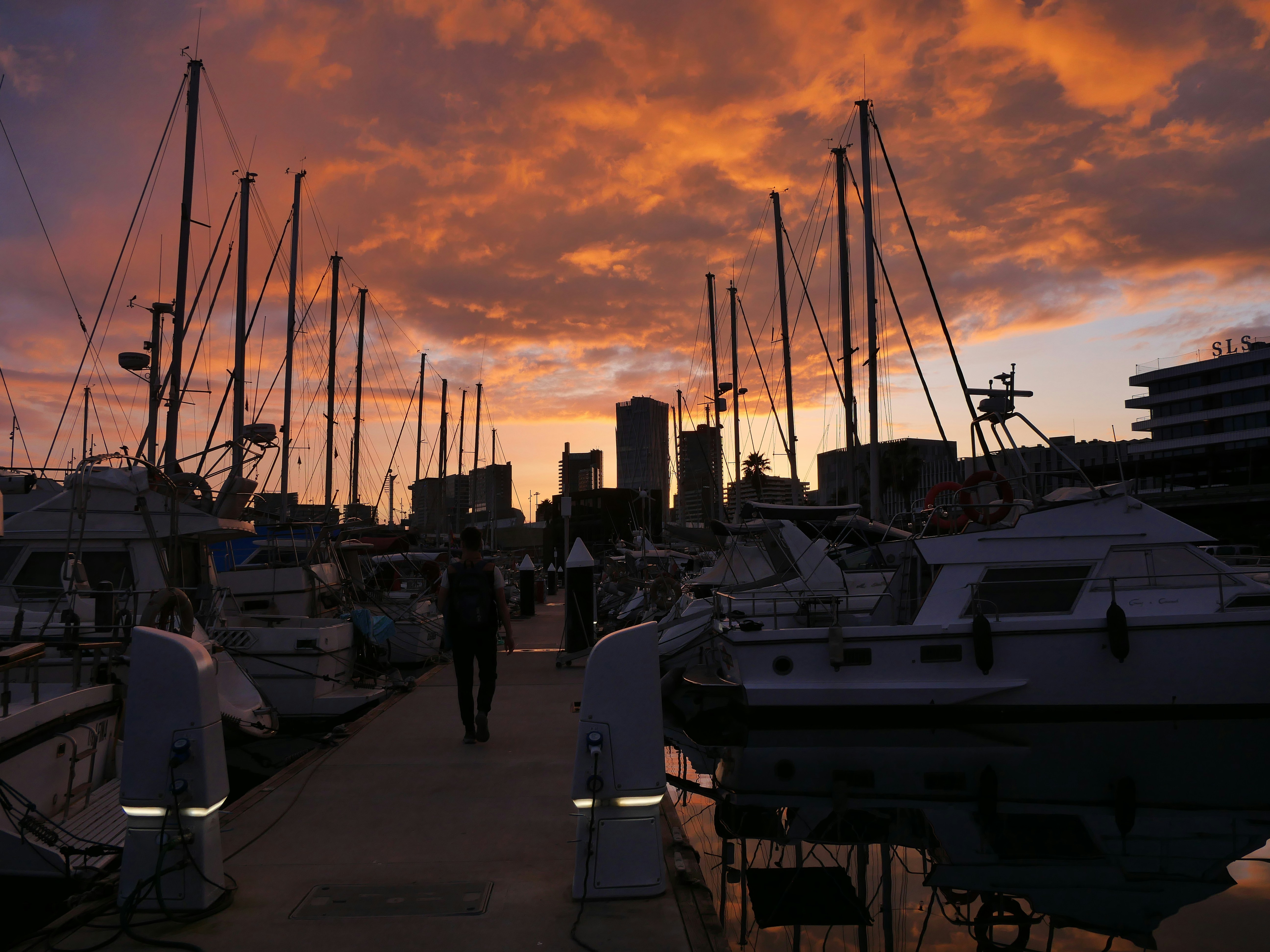 Sunset Marina: Shadowed Walkway Toward Dusklit Yachts