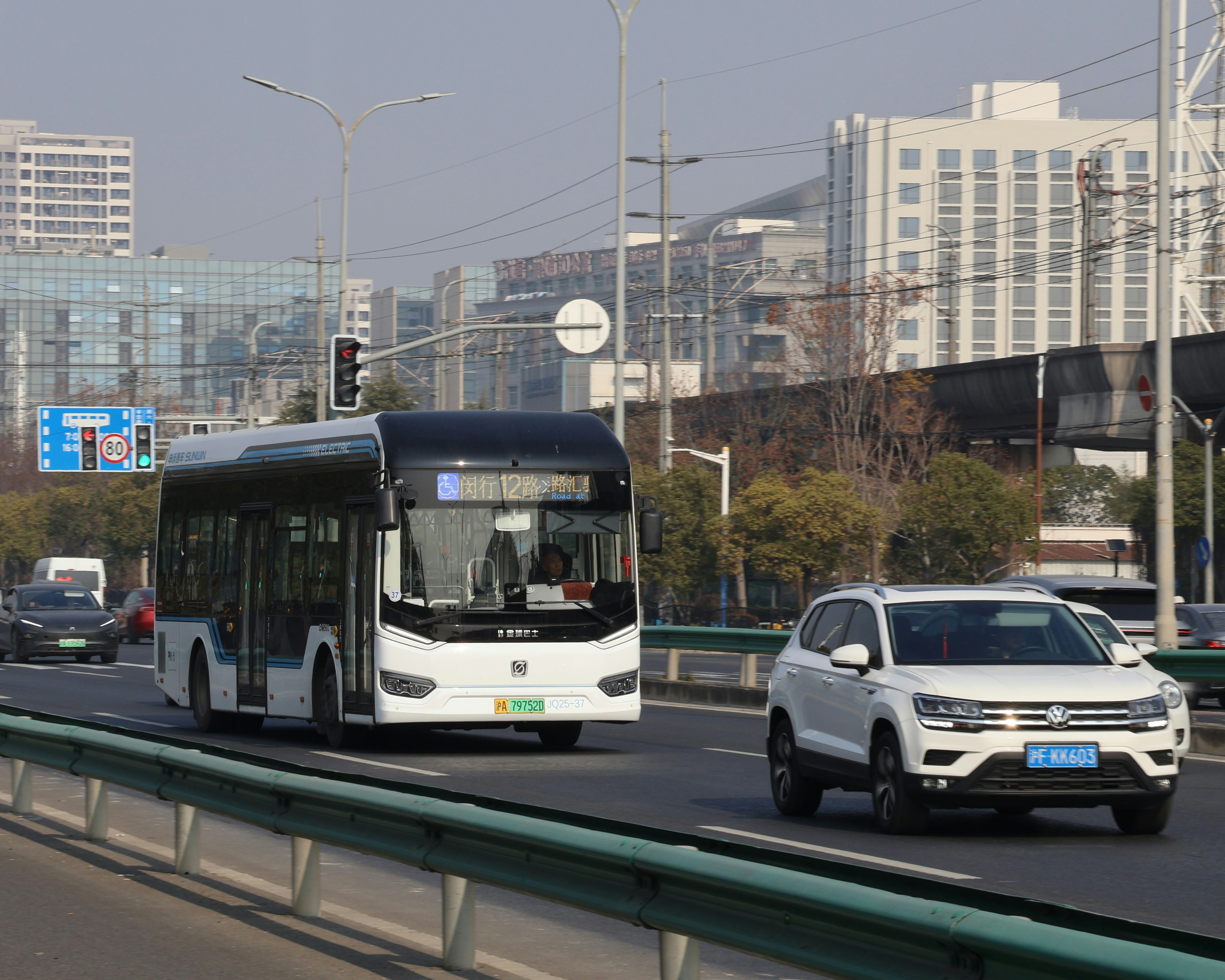 Urban Transit in Motion: White SUV and Modern Bus on a Busy City Highway