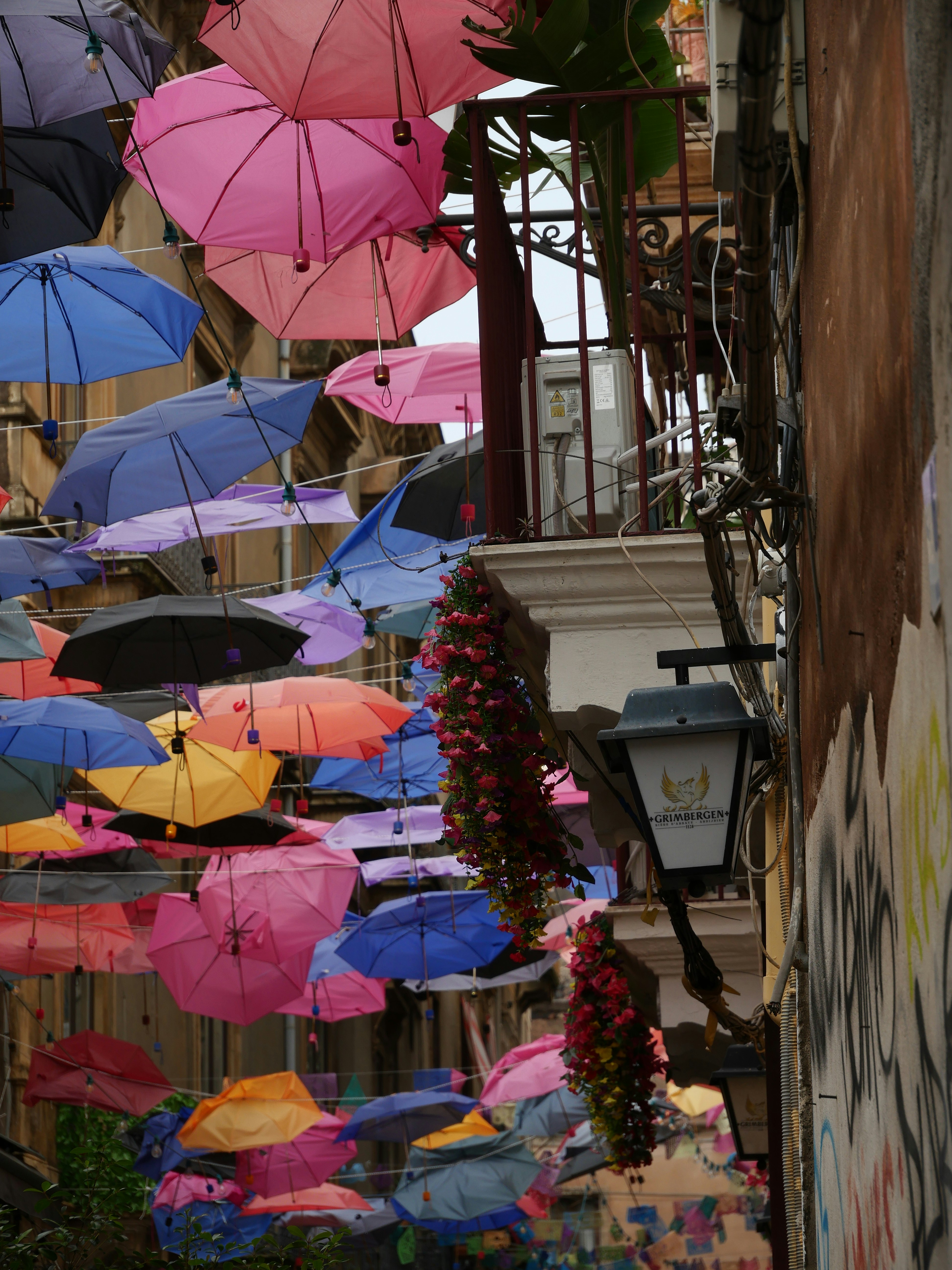 Streetsilk of Color: Umbrella Canopy Over a Narrow Alley